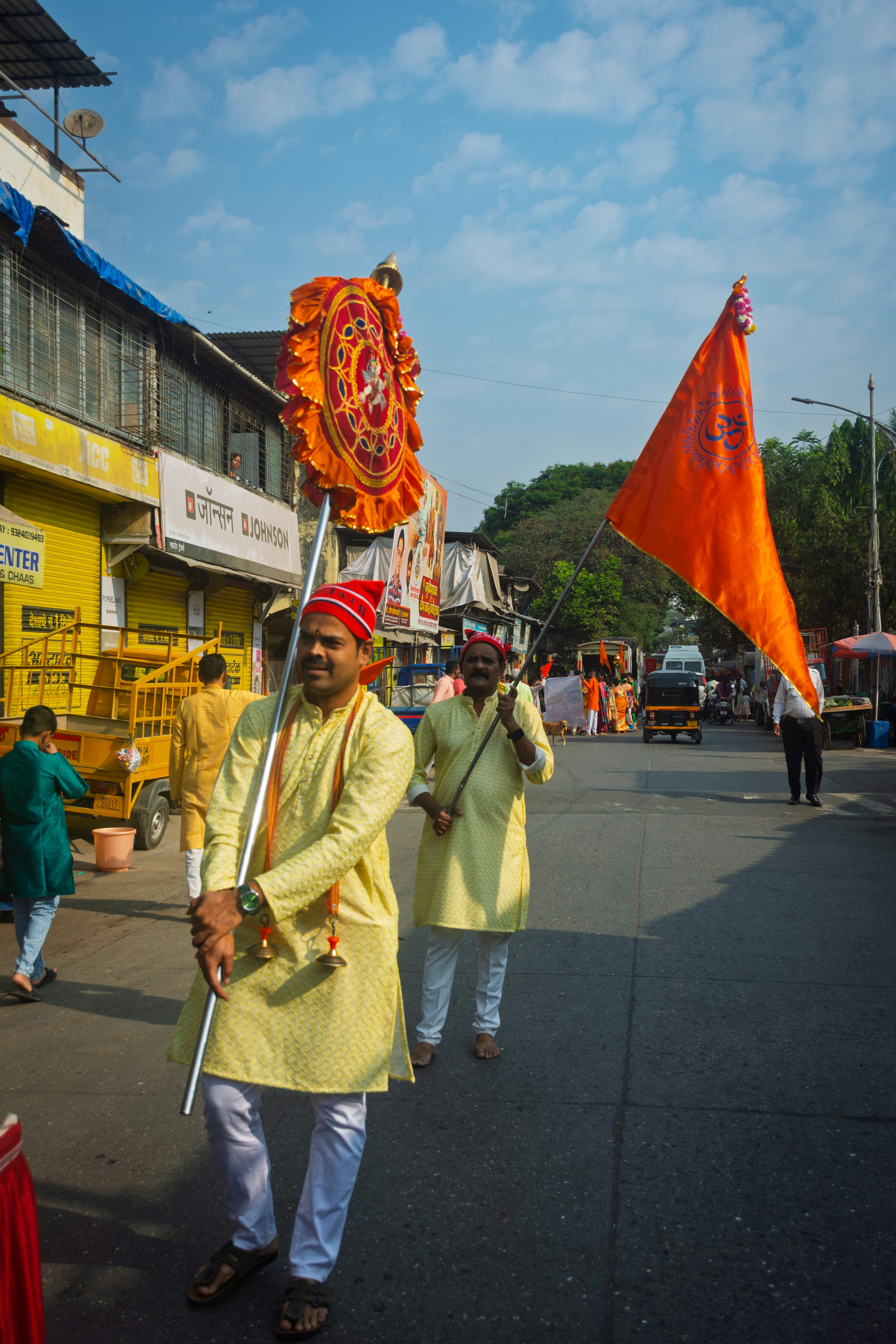 Processional Banner Bearer on a Sunny Indian Street