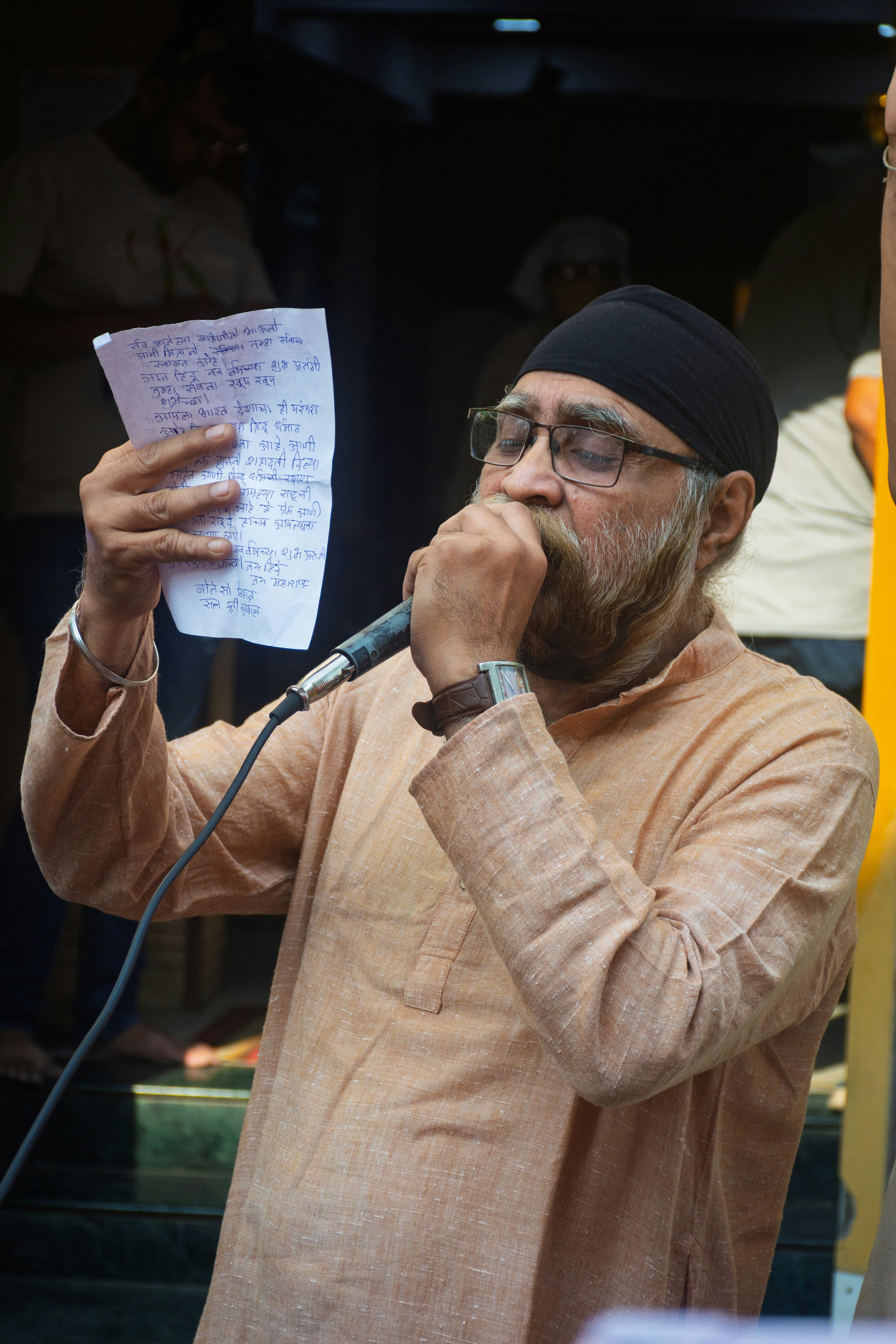 Solo Singer with Script in Hand under Dark Backdrop