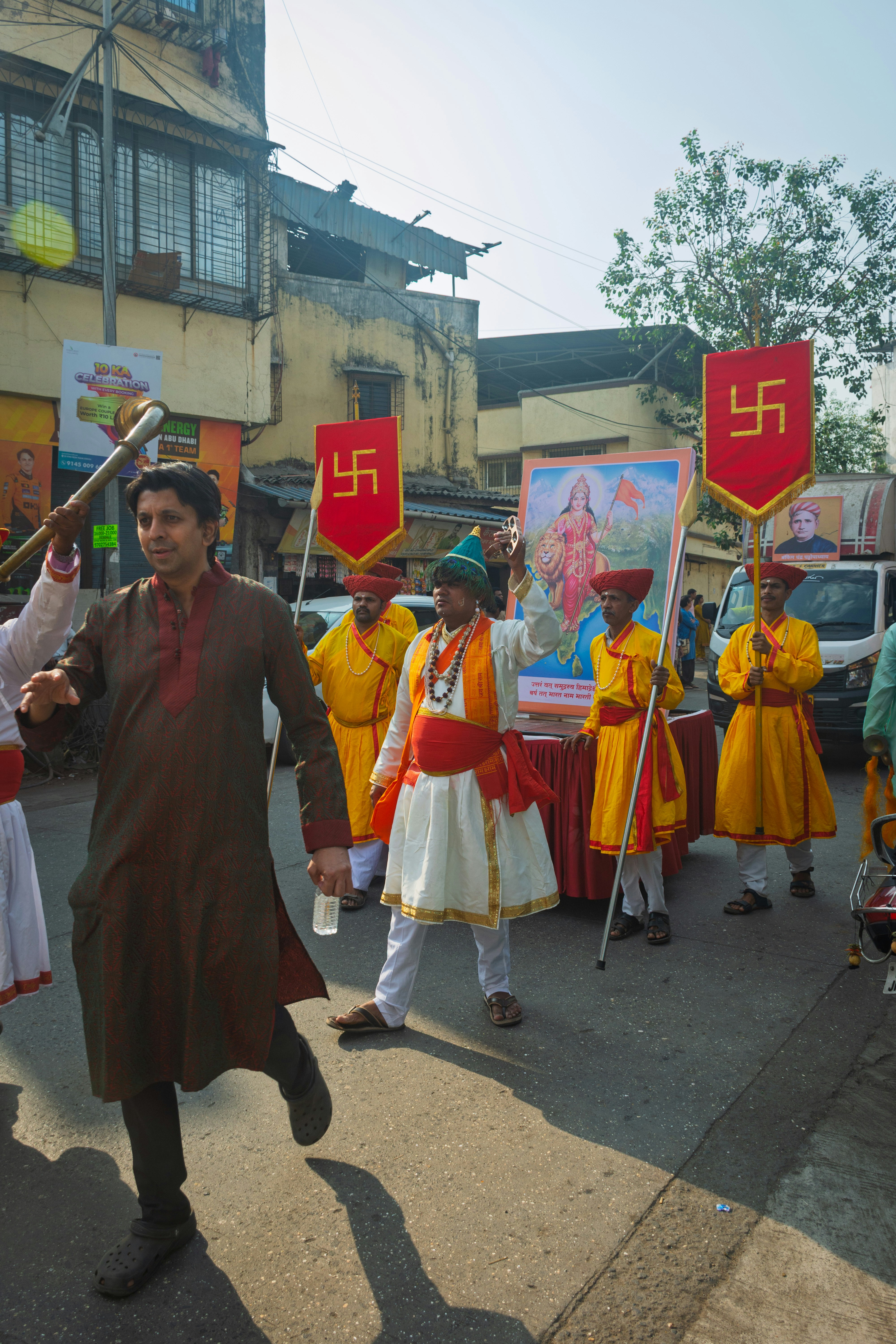 Street Procession in Color: A Traditional Parade with Swastika Banners