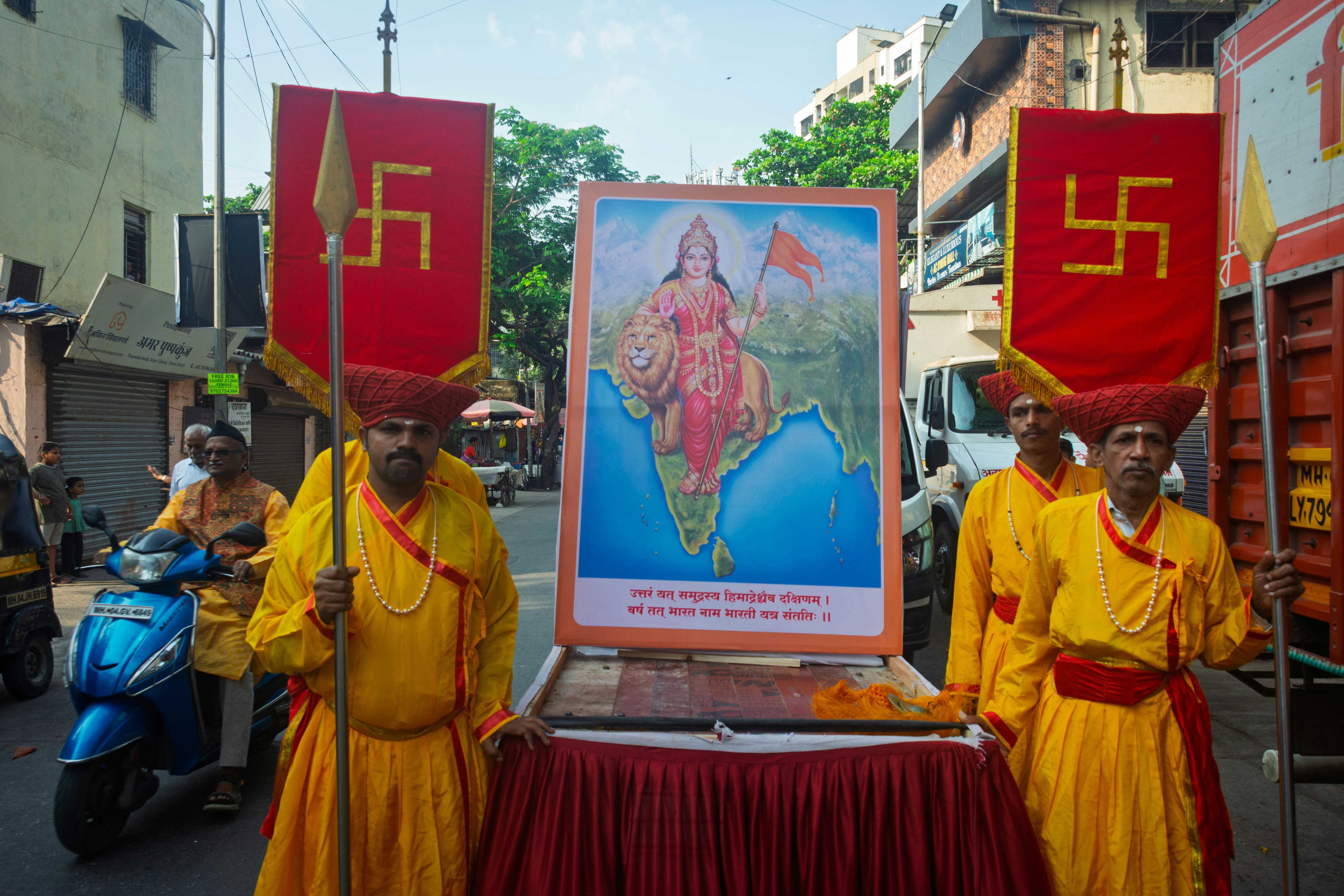 Ritual Procession: A Hindu Shrine Frame Anchored by Bright Maharashtrian Attire