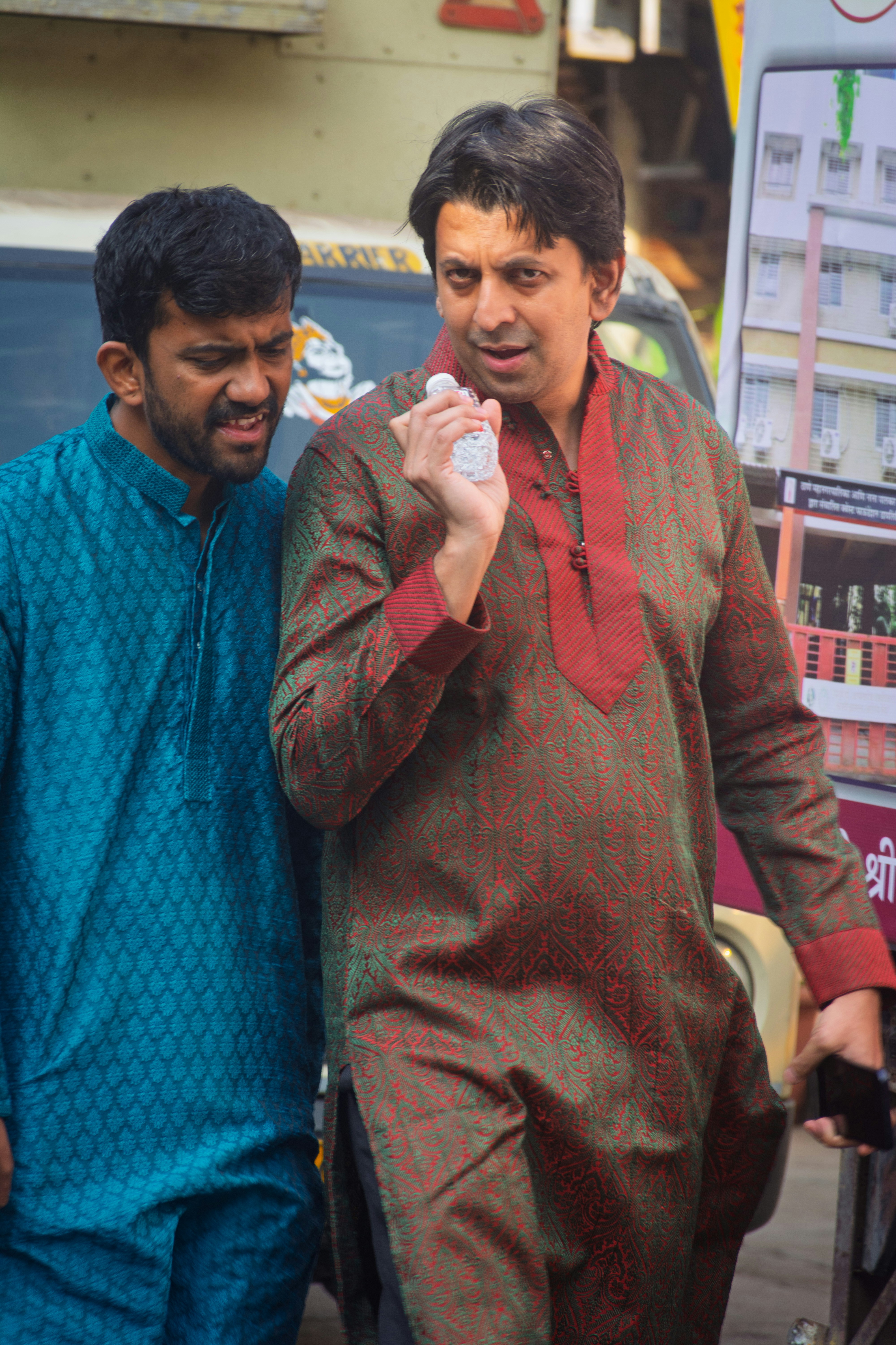 Two Friends in Vibrant Desi Attire Share a Moment on the Street