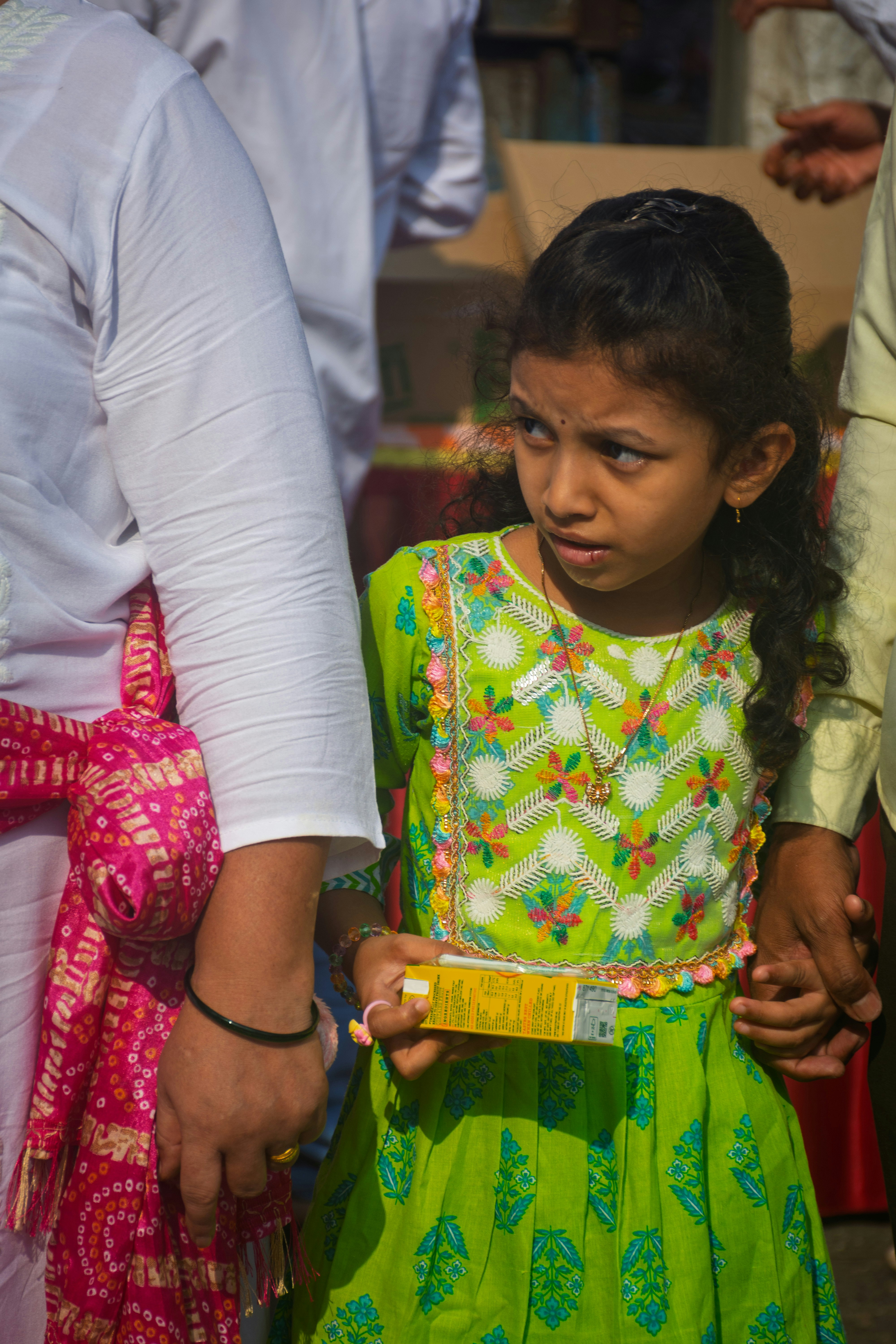 Bright Green Confidences: A Young Girl in a Radiant Traditional Dress