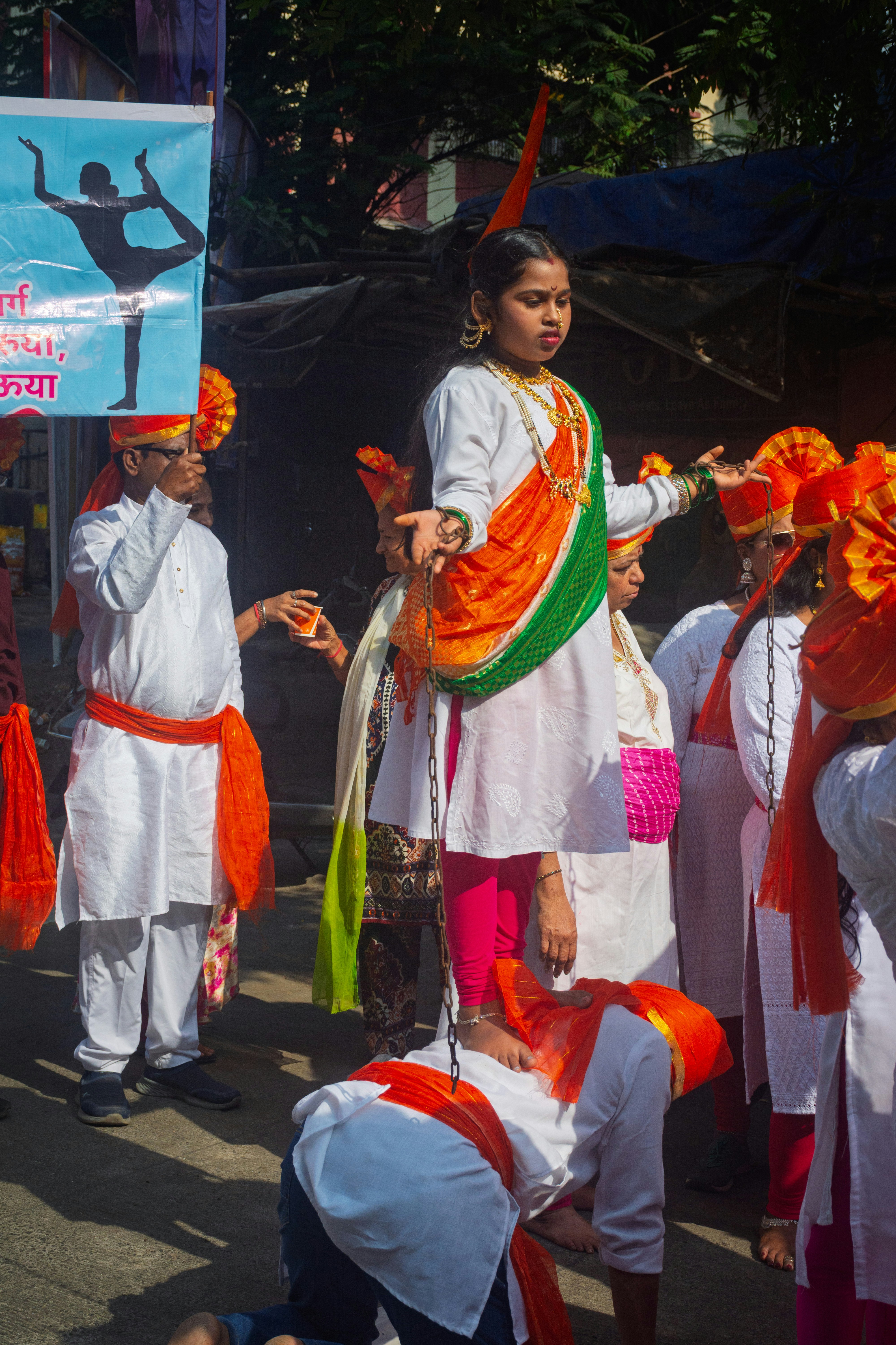 Colorful Heritage: A Dancer Reaches for the Sky Amid a Festival Crowd