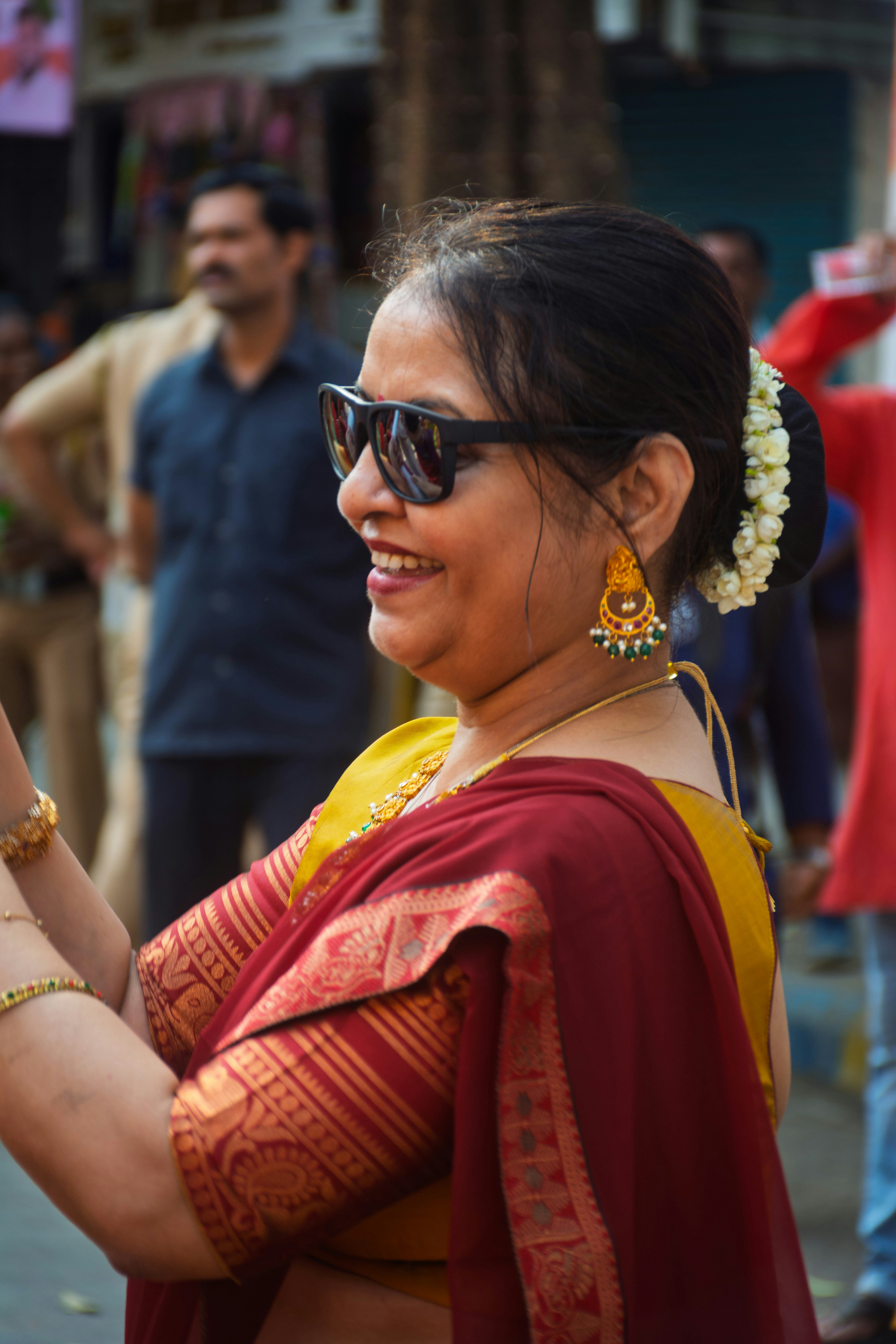 Joyful Entourage: A Smiling Moment in Sunset Sari
