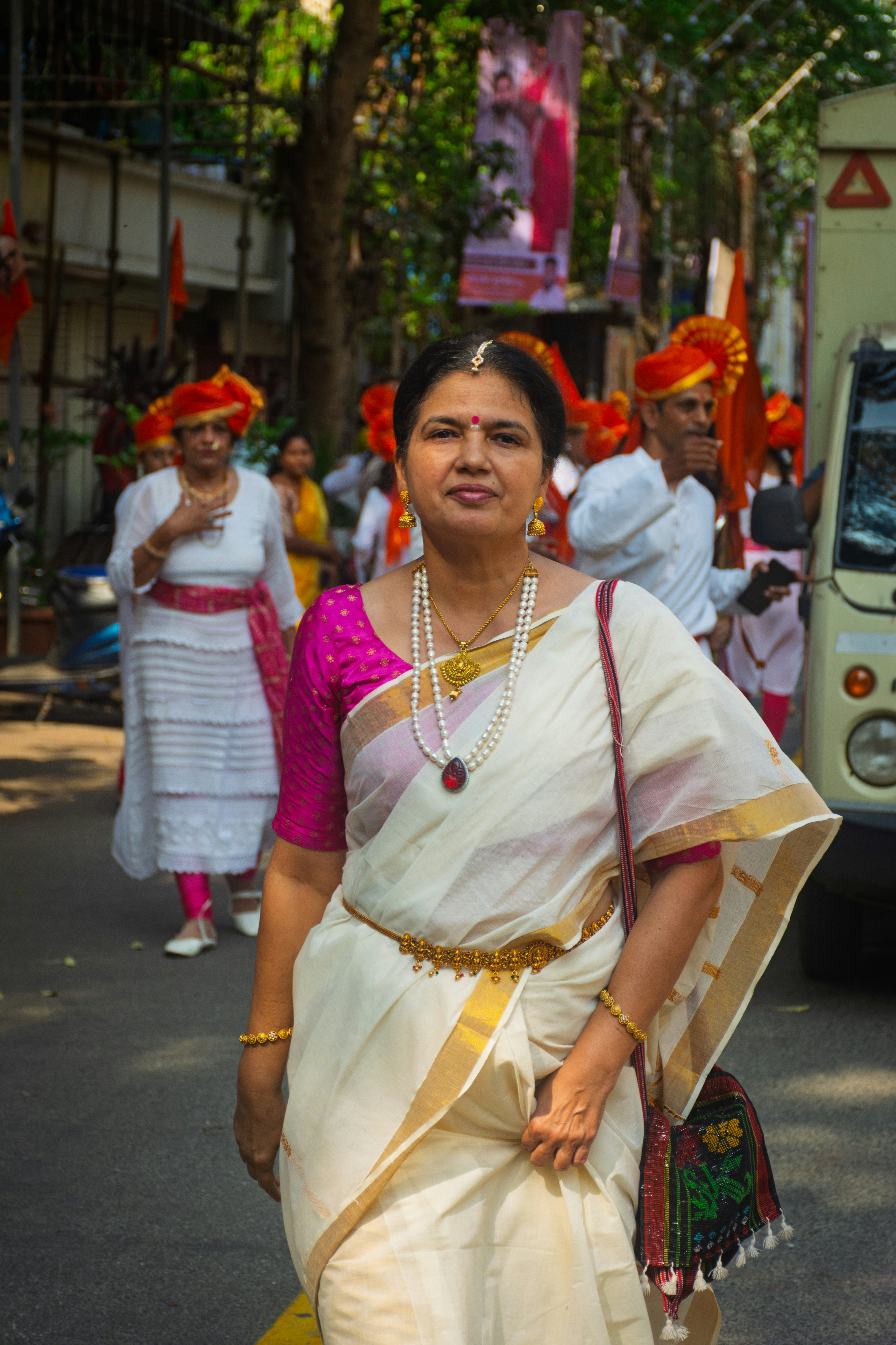 Ceremonial Grace in White and Gold: A Street Parade Portrait