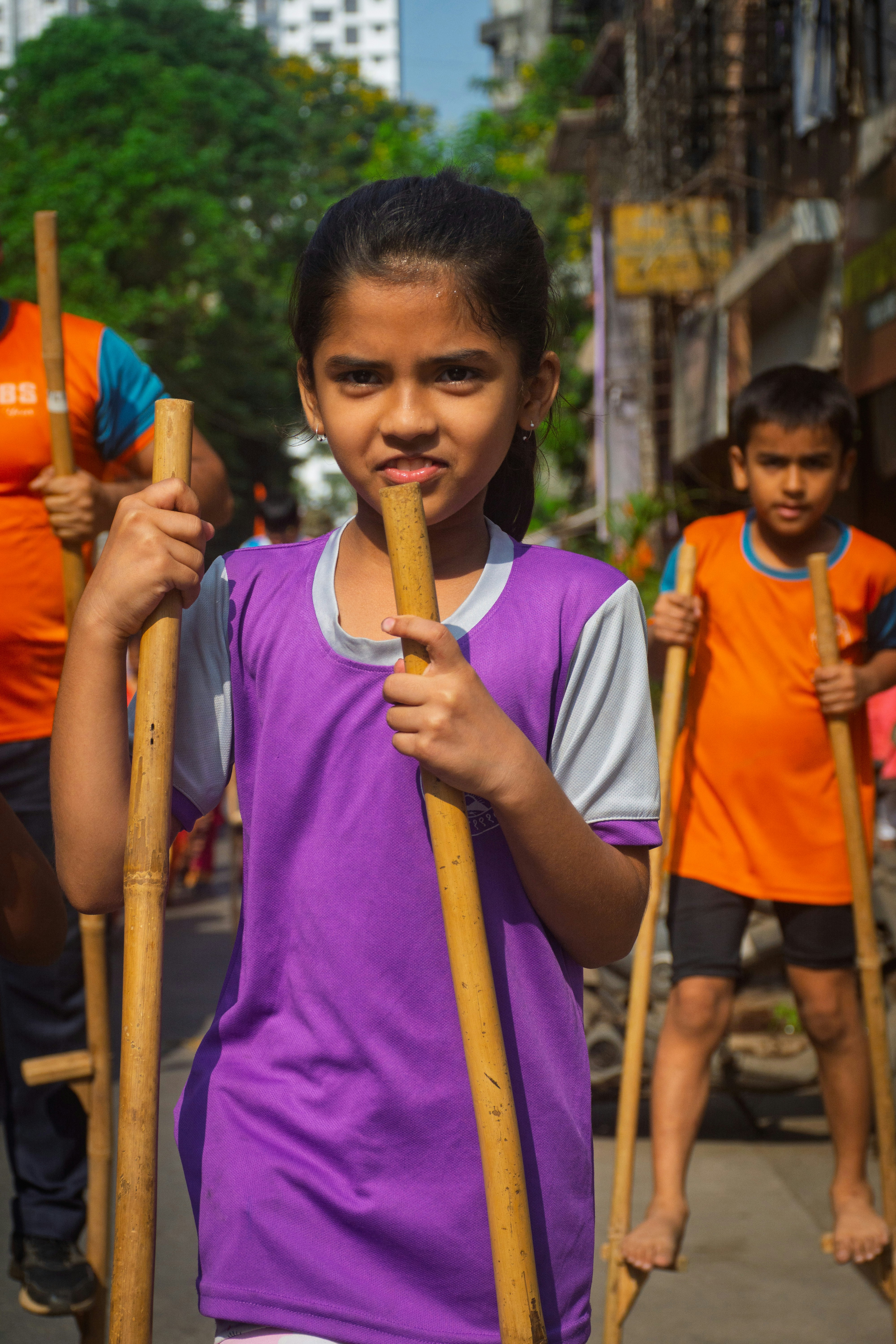 Purple-edged Focus: A Girl Leads a Bamboo Parade
