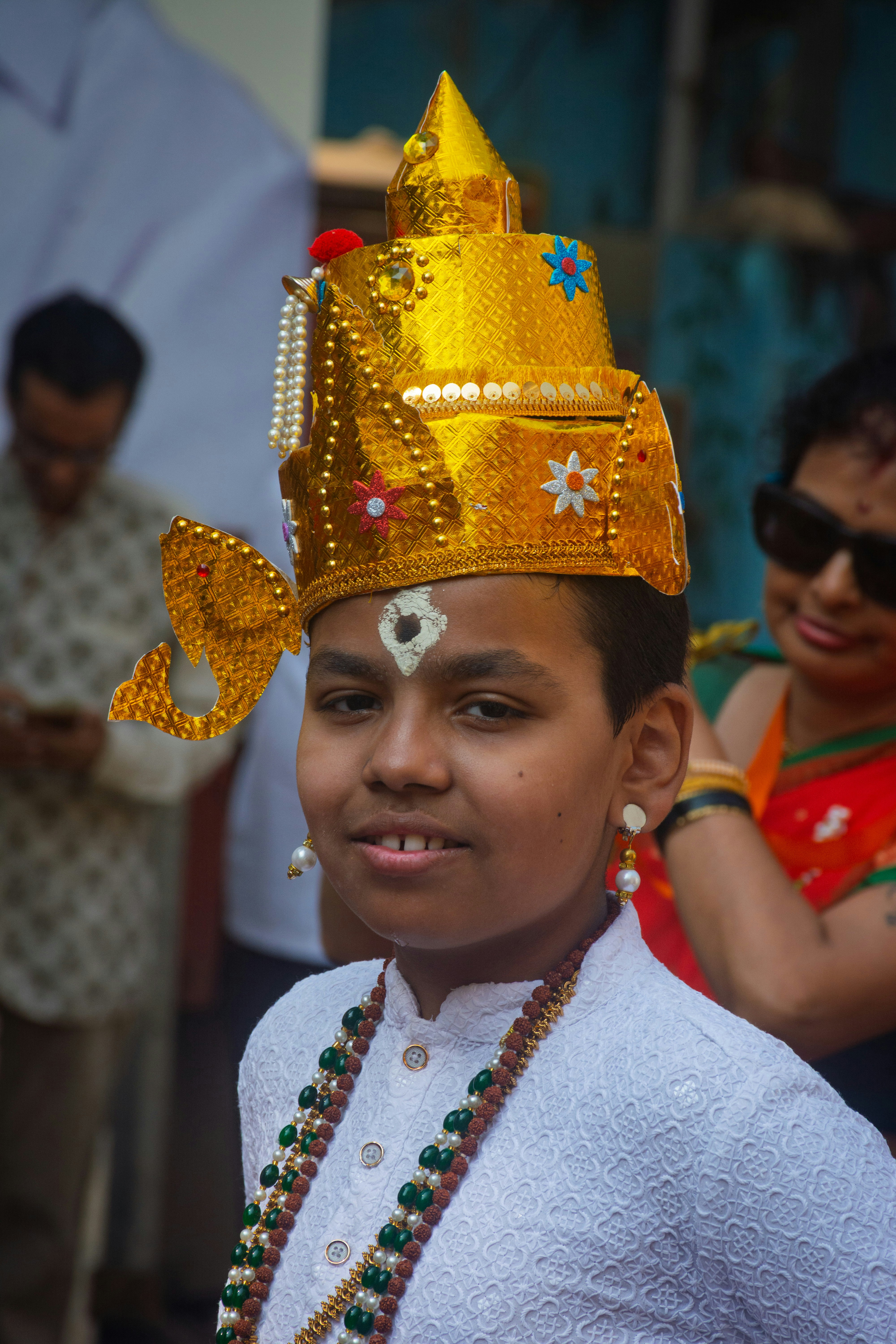Golden Crown, Bright Smile: A Young Performer in Festival Attire