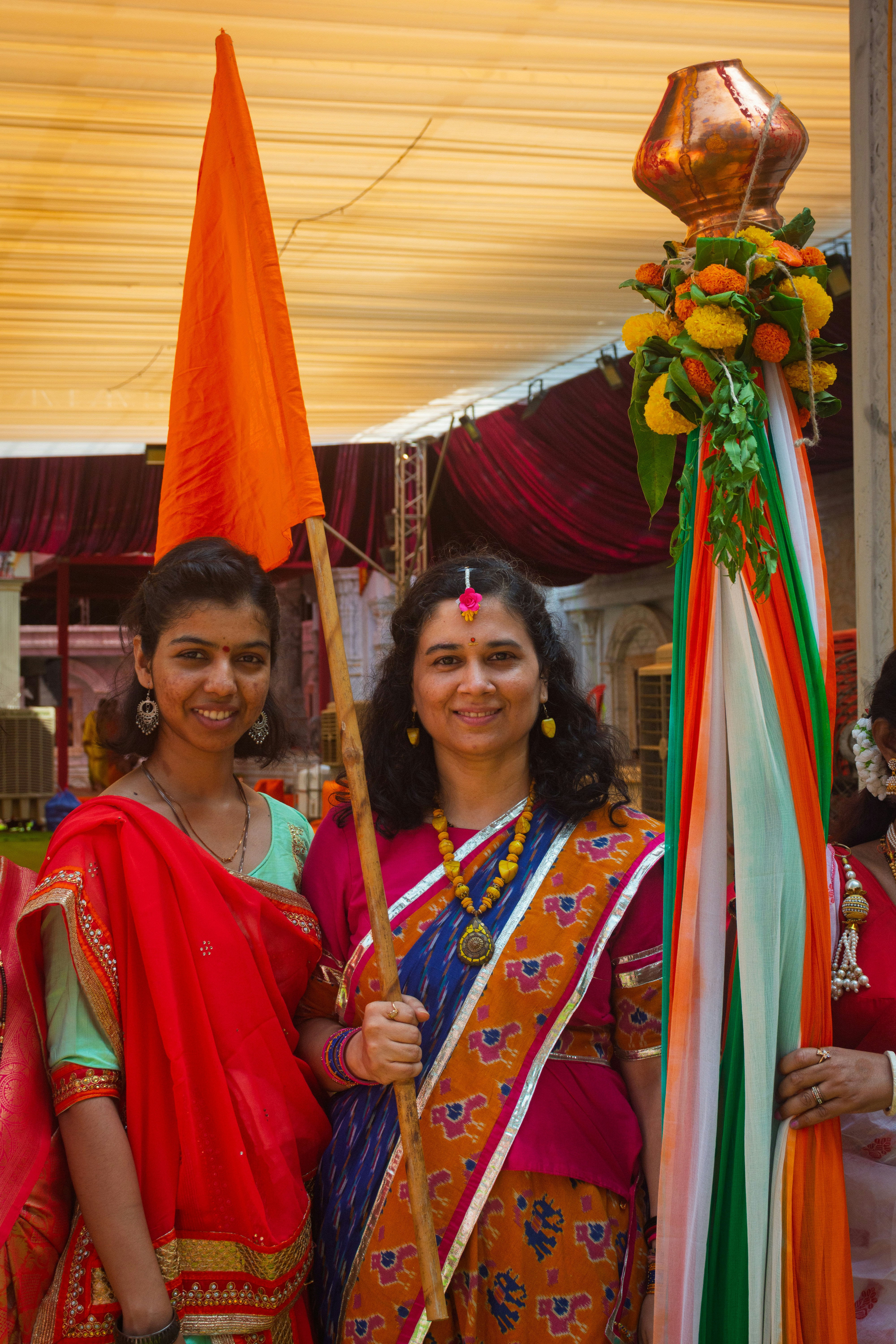 Celebration Portrait: Two Women in Vibrant Sarees Under Festive Decor