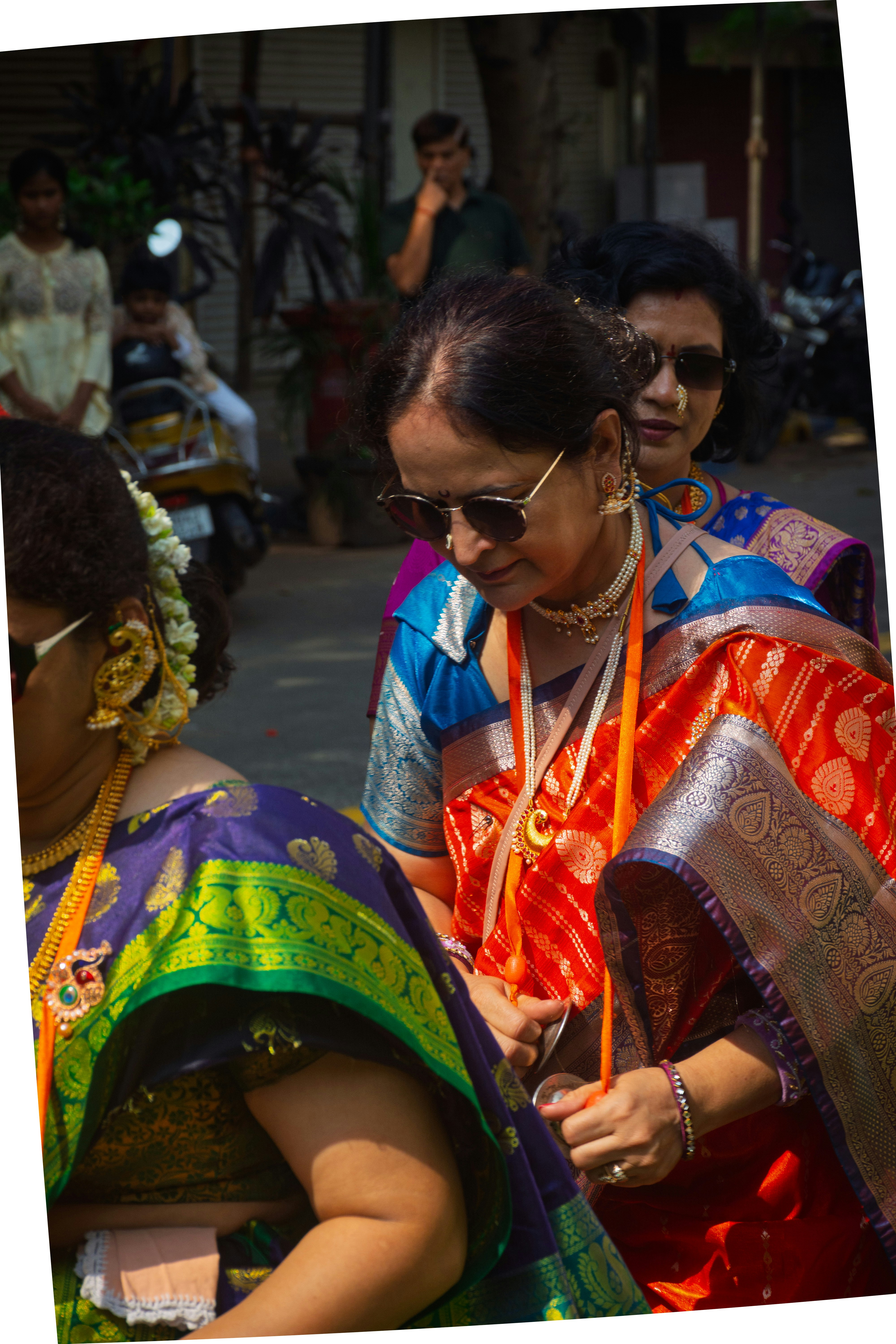 Vibrant Sarees and Focused Grace: A Moment in Colorful Ceremony
