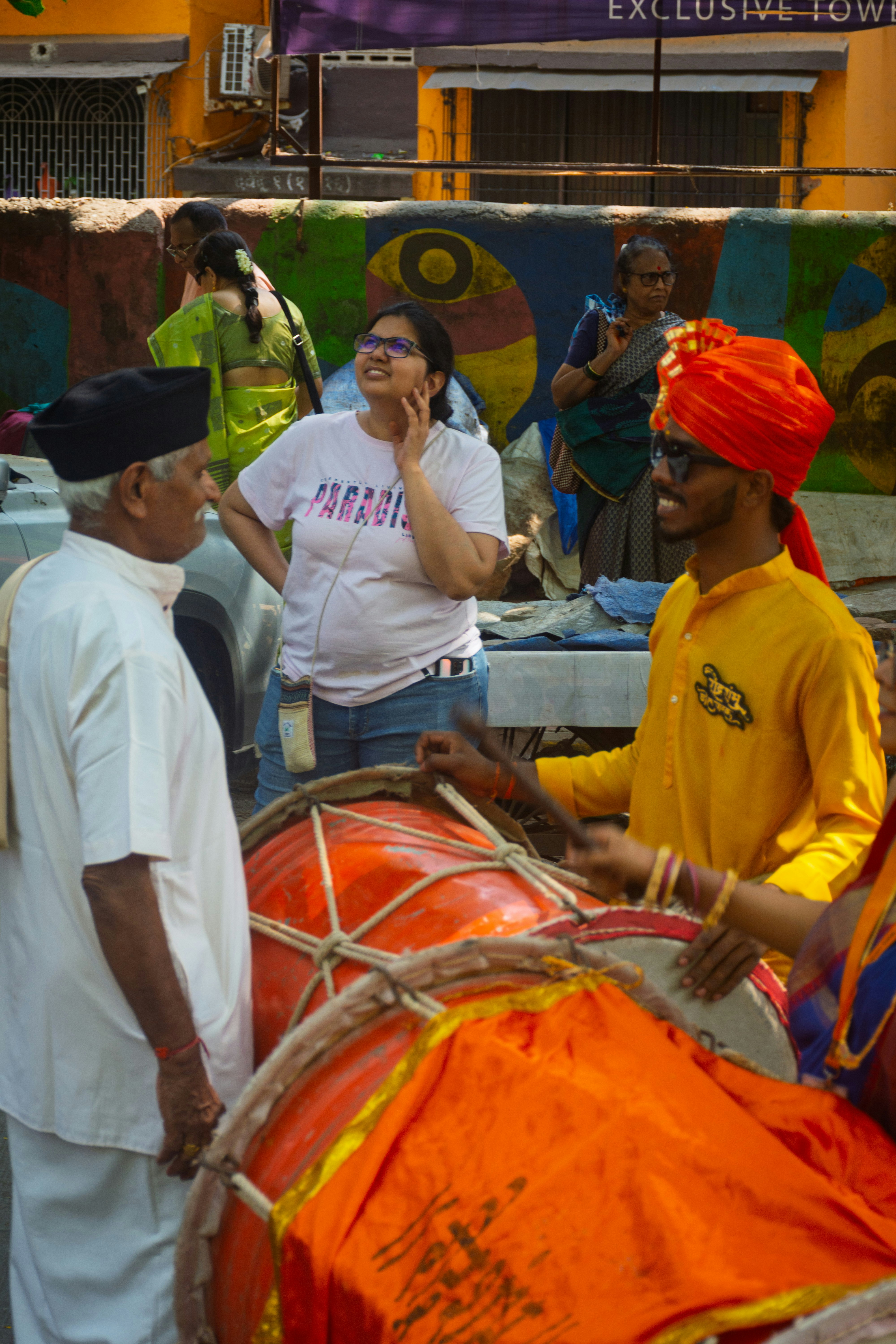 Colorful Street Scene with Drums and Curious Onlooker