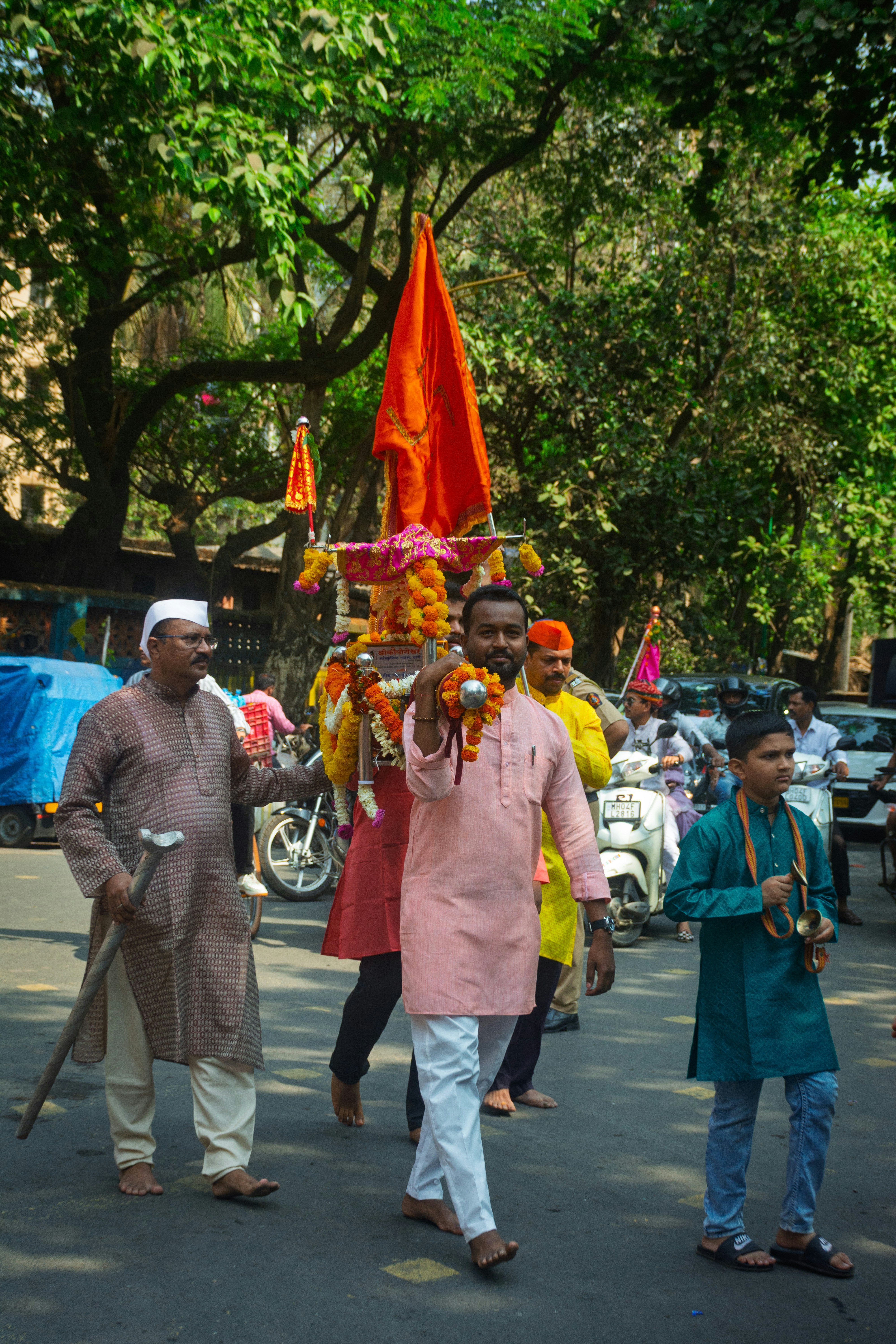 Procession of Color: A Shrine Bearer Leads through a Sunlit Street