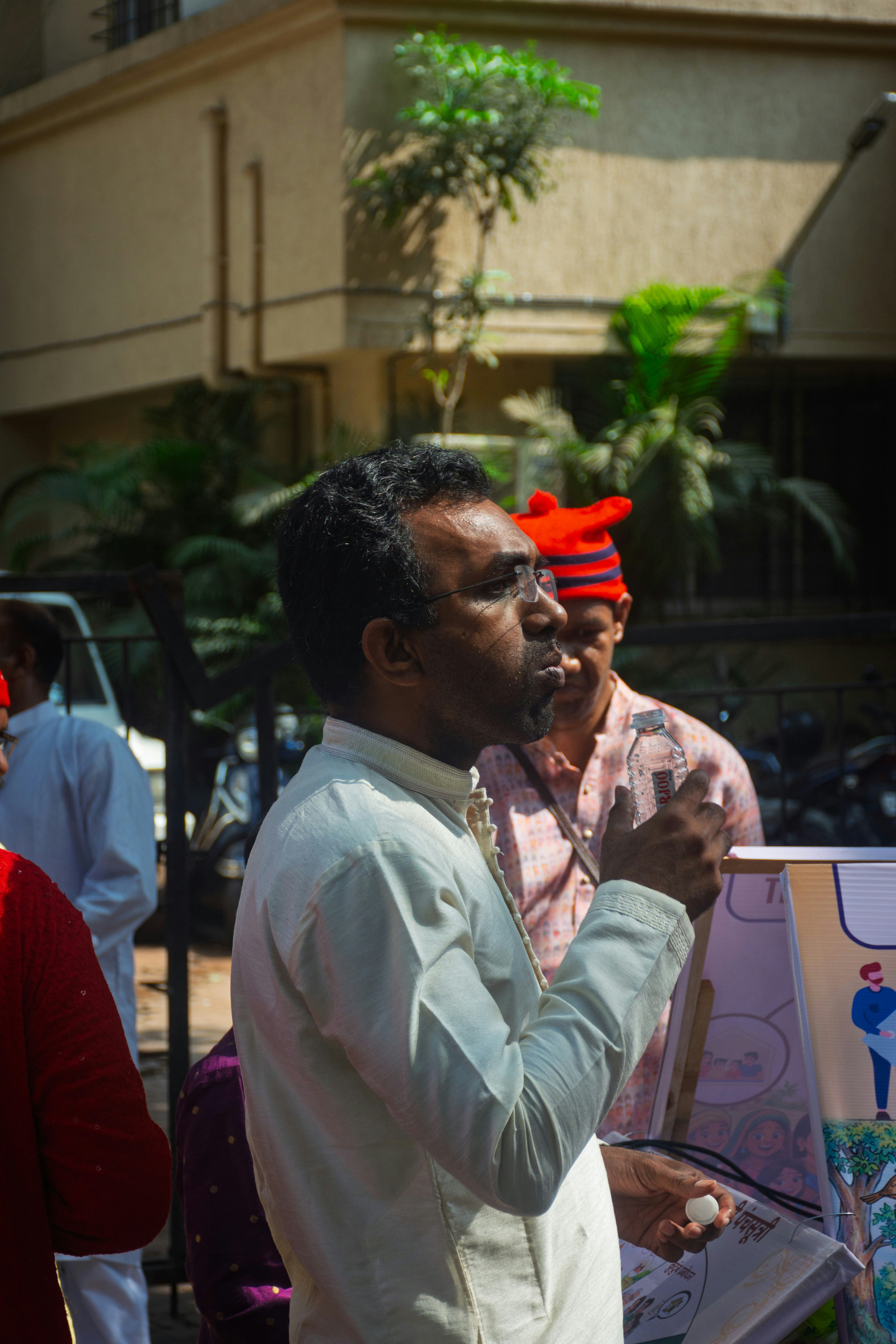 Speaking in Focus: A Moment of Expression at a Vibrant Outdoor Scene
