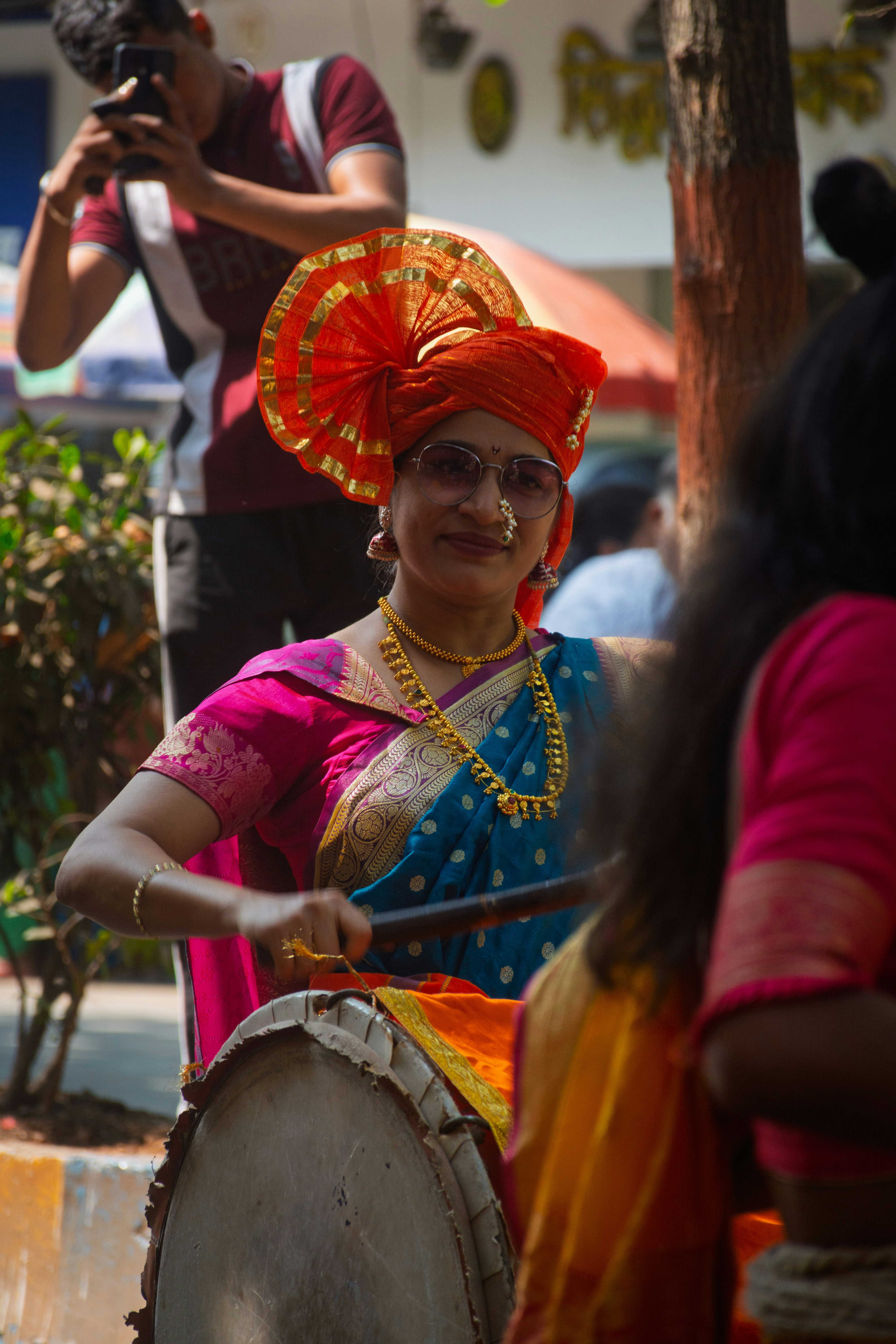 Drummer in Traditional Attire Captures a Moment of Color and Rhythm