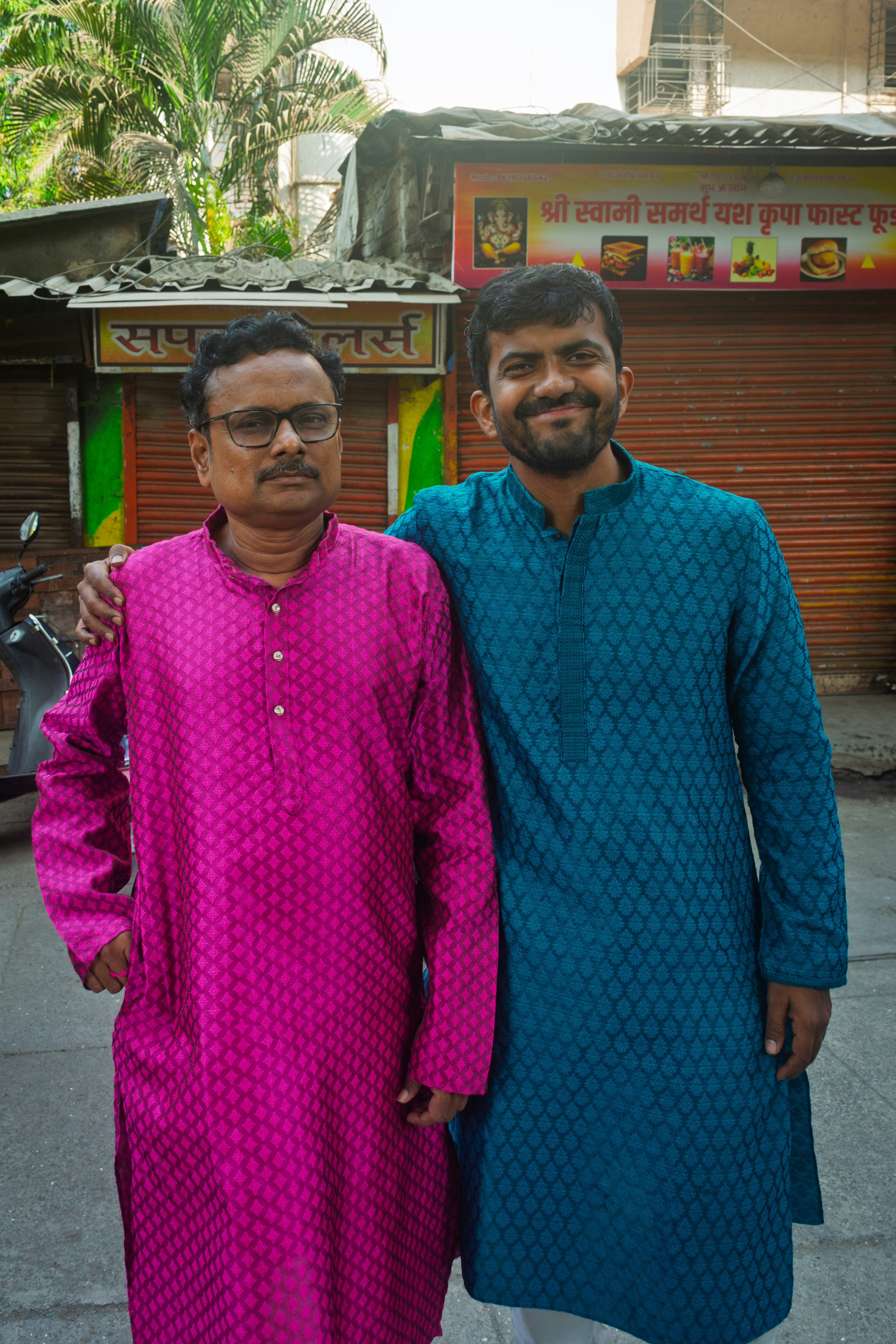 Twin Threads of Color: A Brotherly Moment in Vibrant Traditional Wear