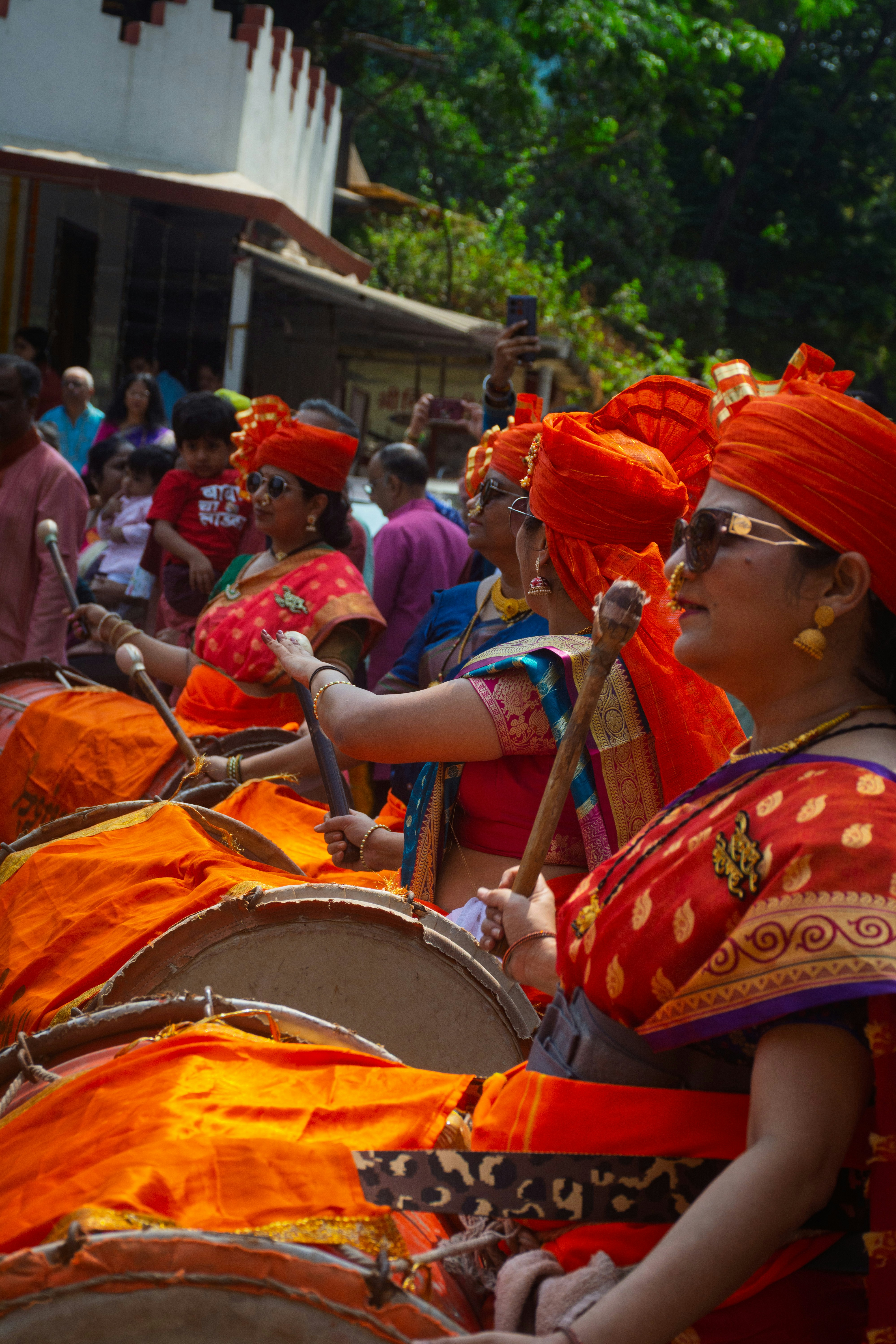 Bright Orange Rites: A Drum Procession in vivid Hindu festival attire