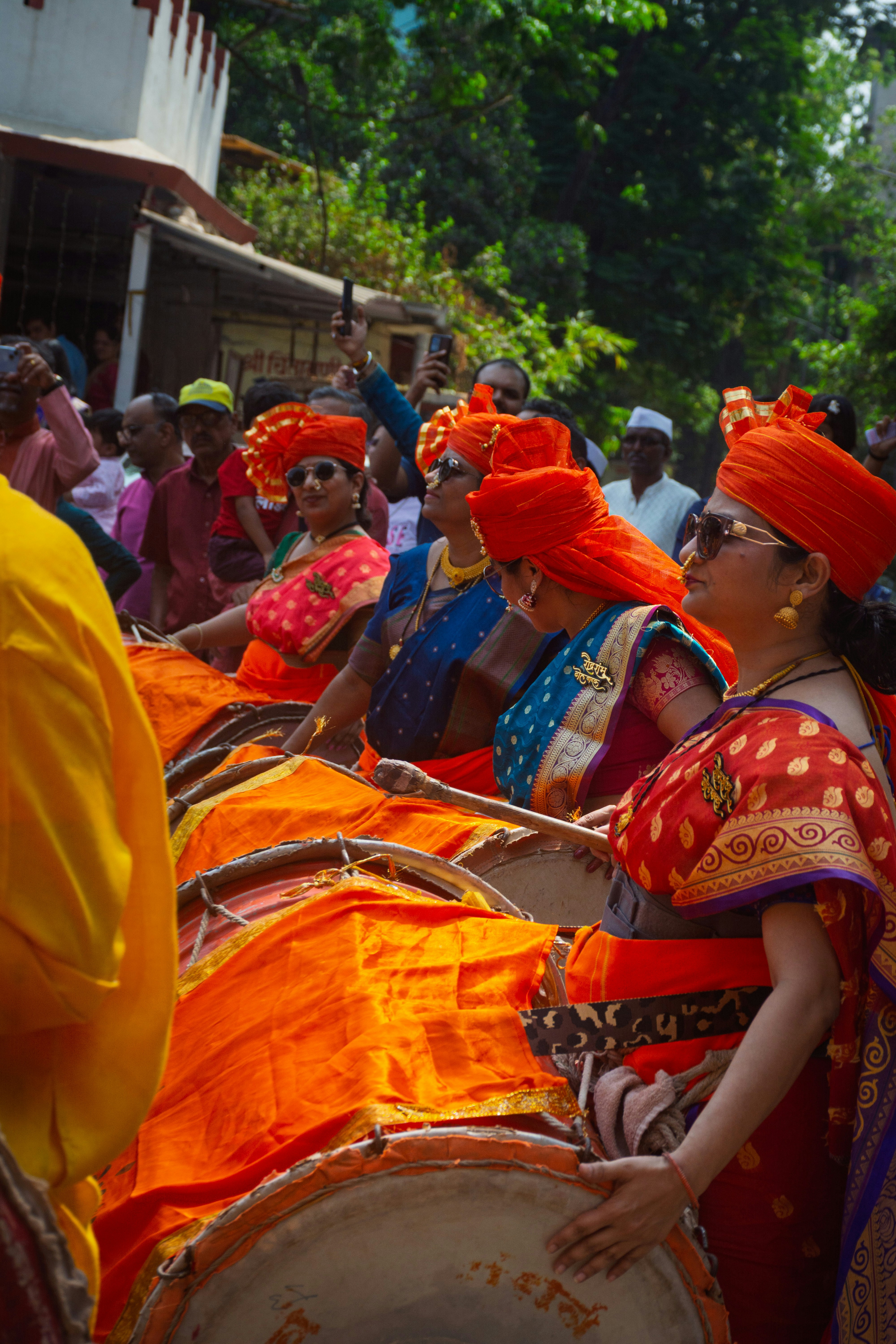 Powdered Orange Rhythm: Drummers in a Festive Street Procession