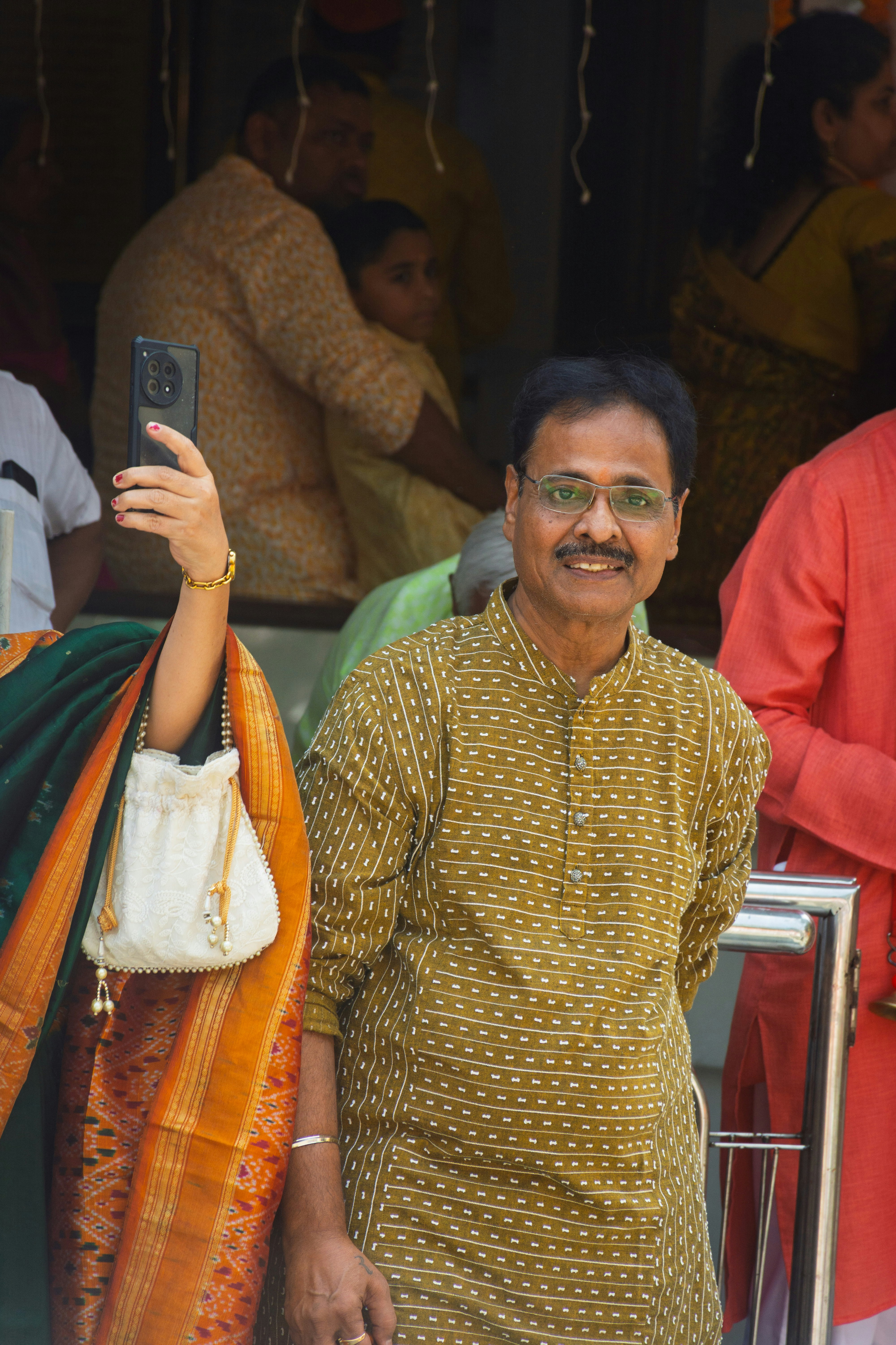 Smiling Gentleman in Patterned Kurta Captures a Social Moment