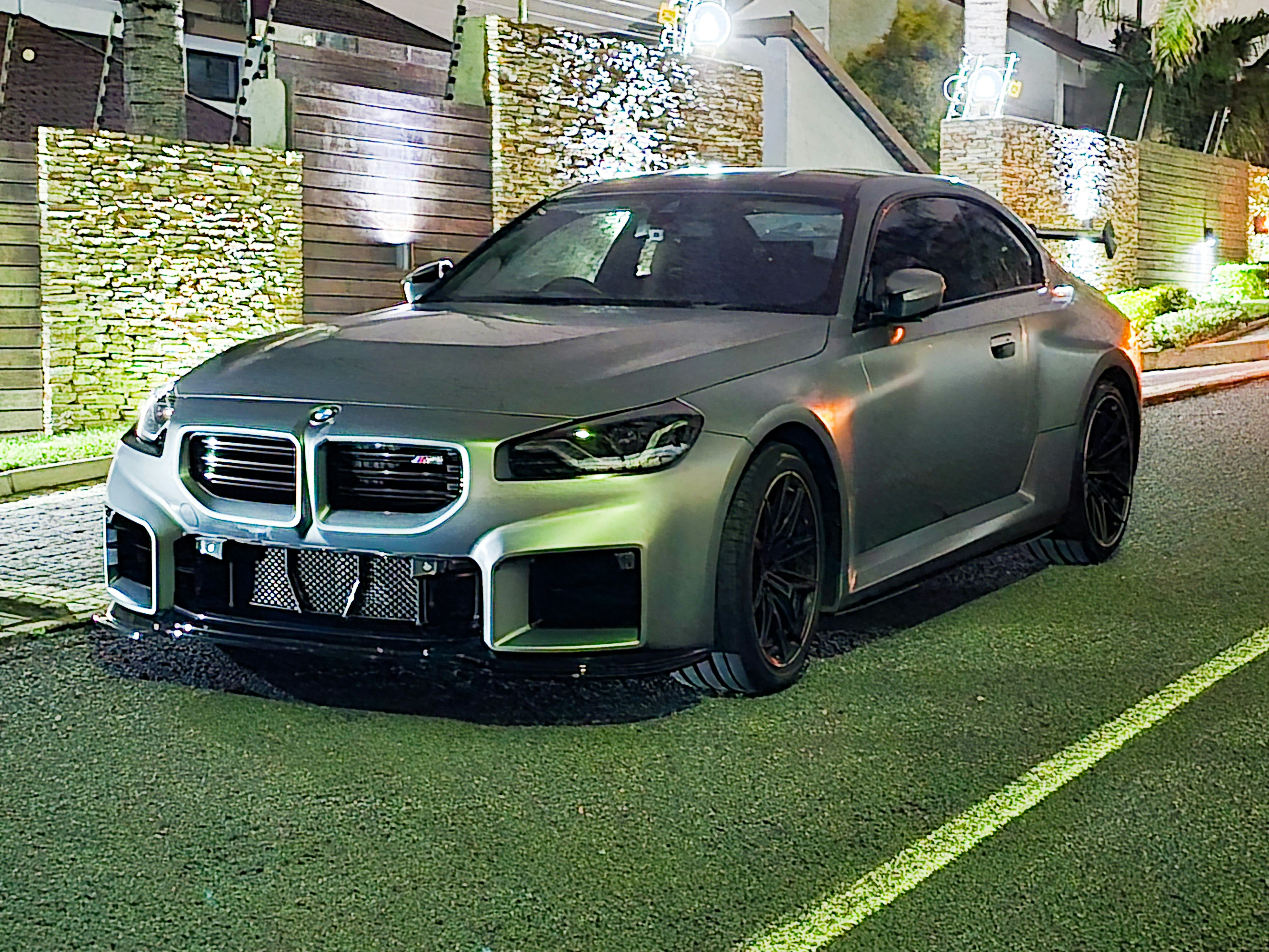 Sleek Night Stance: A Silver BMW M Previewed under Garden Lights