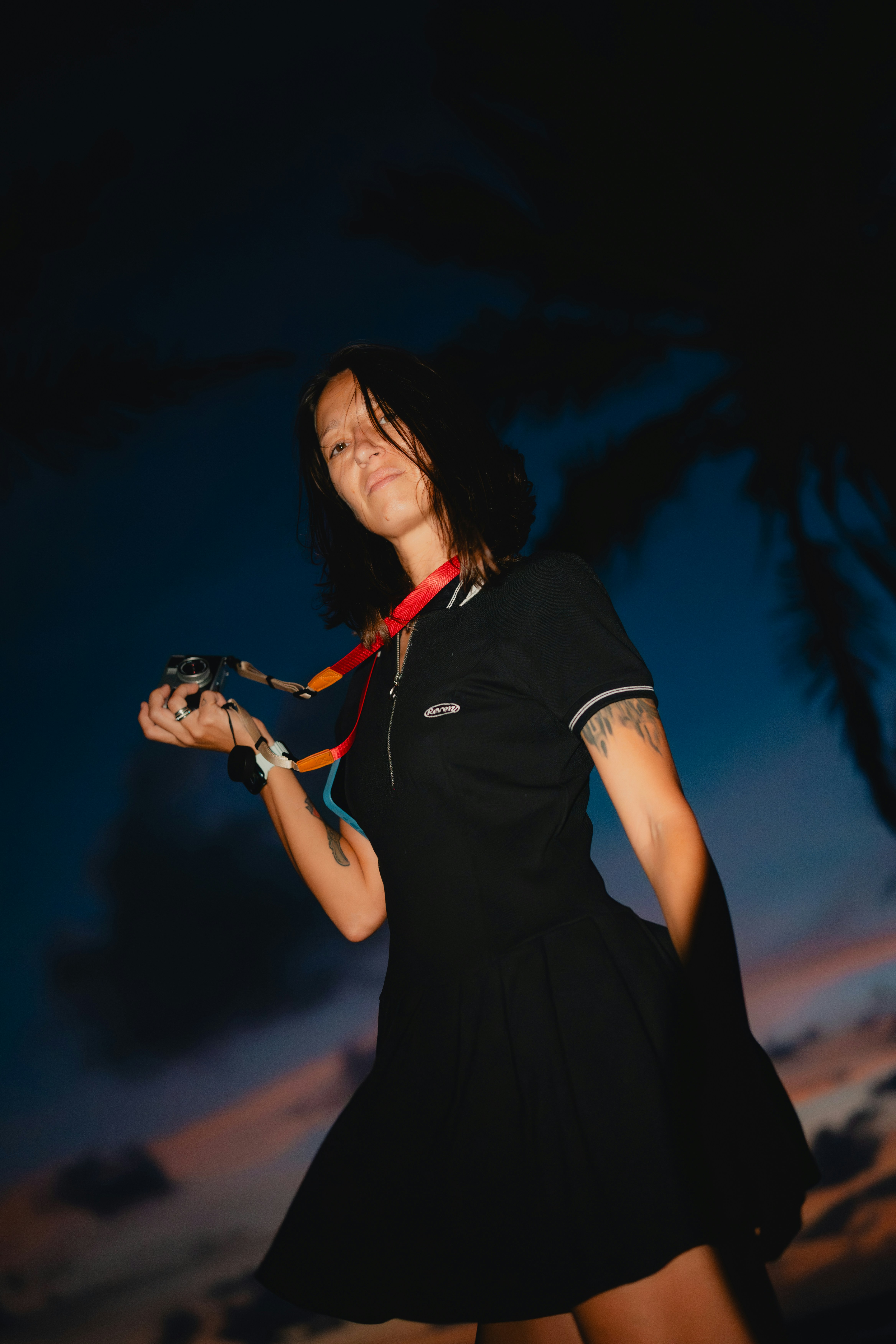Evening Portrait: A Photographer in Focus Under Twilight Sky