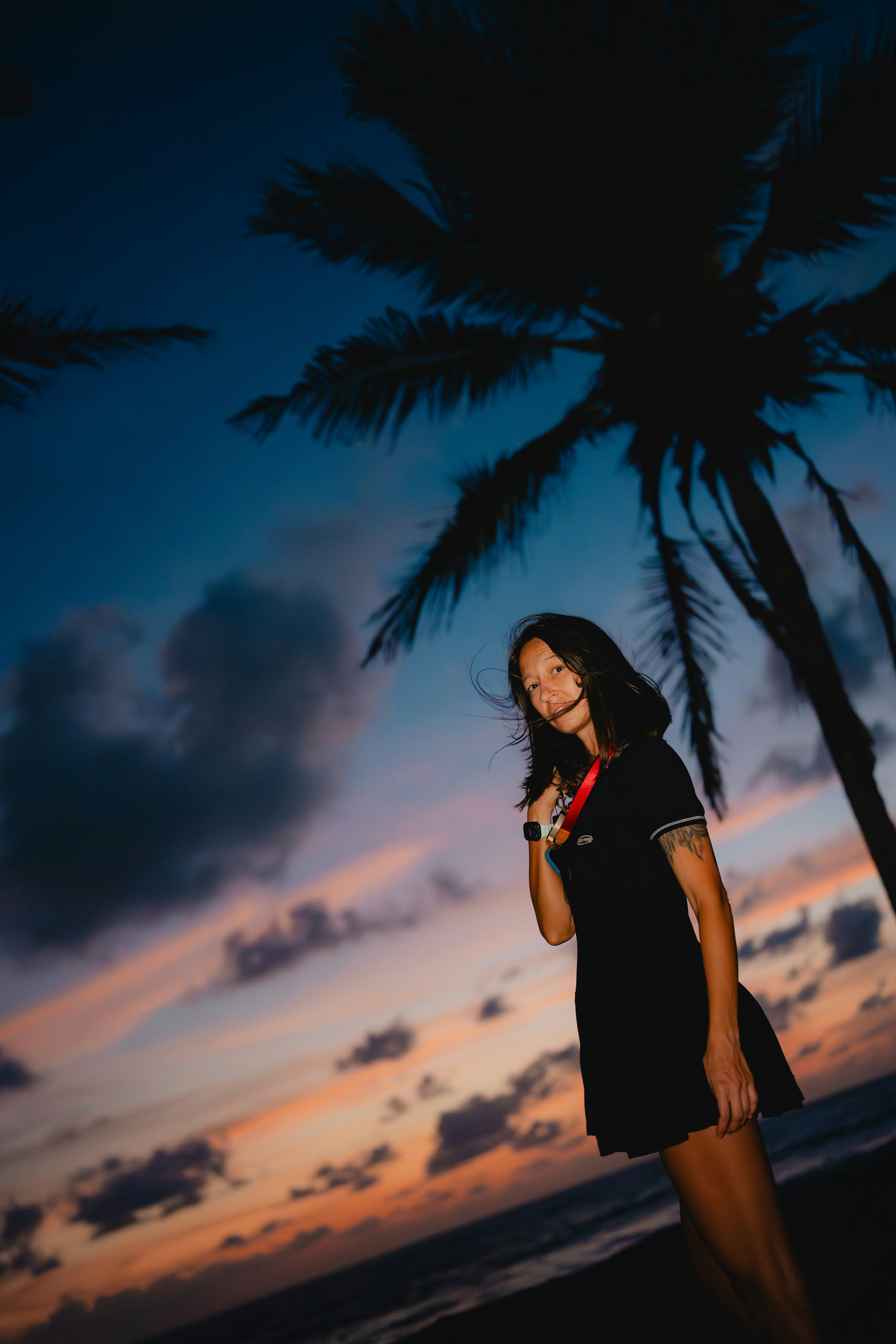 Sunset Silhouette: A Portrait Beneath Palm Canopies