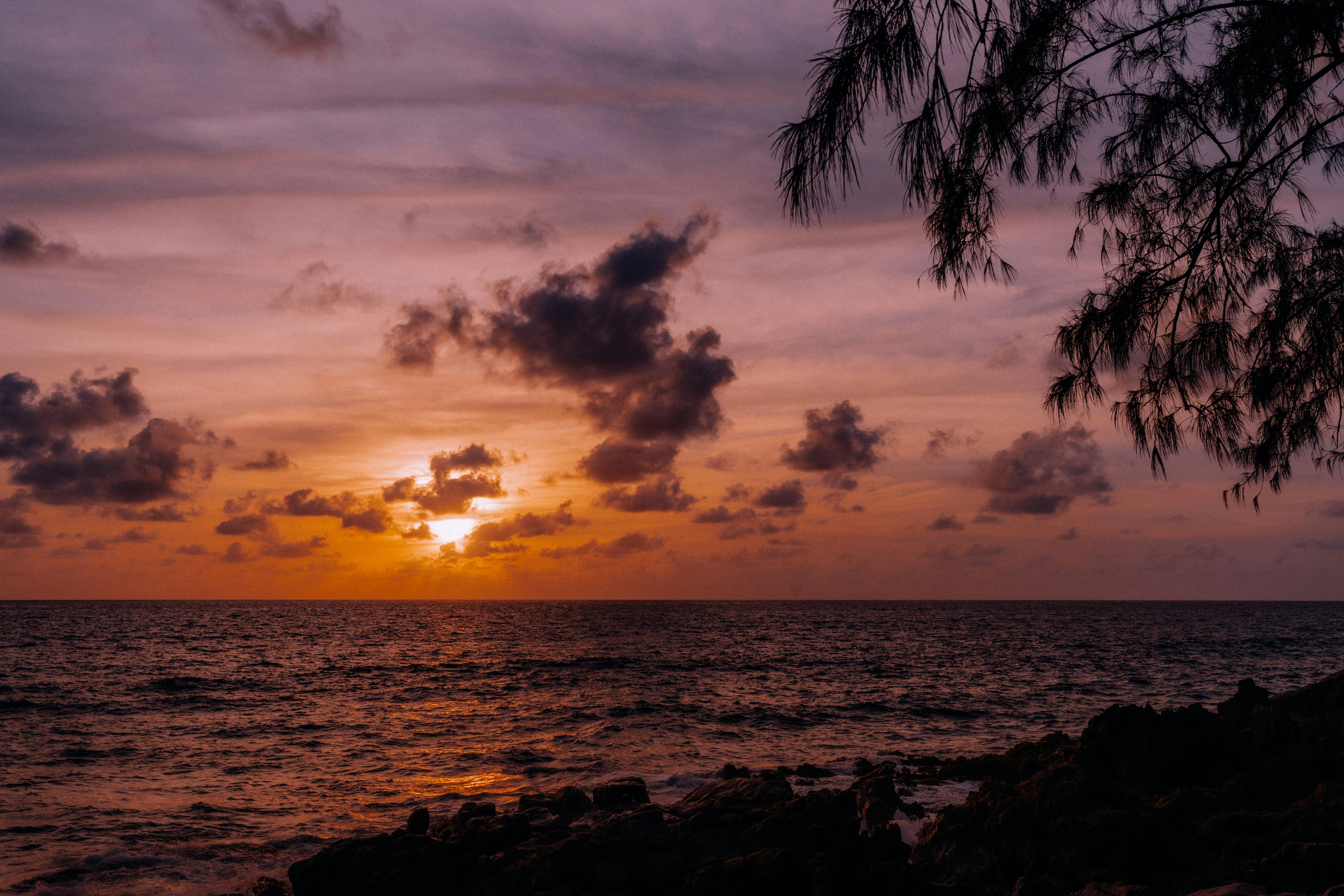 Golden Horizon: Sunset Over a Rocky Shoreline