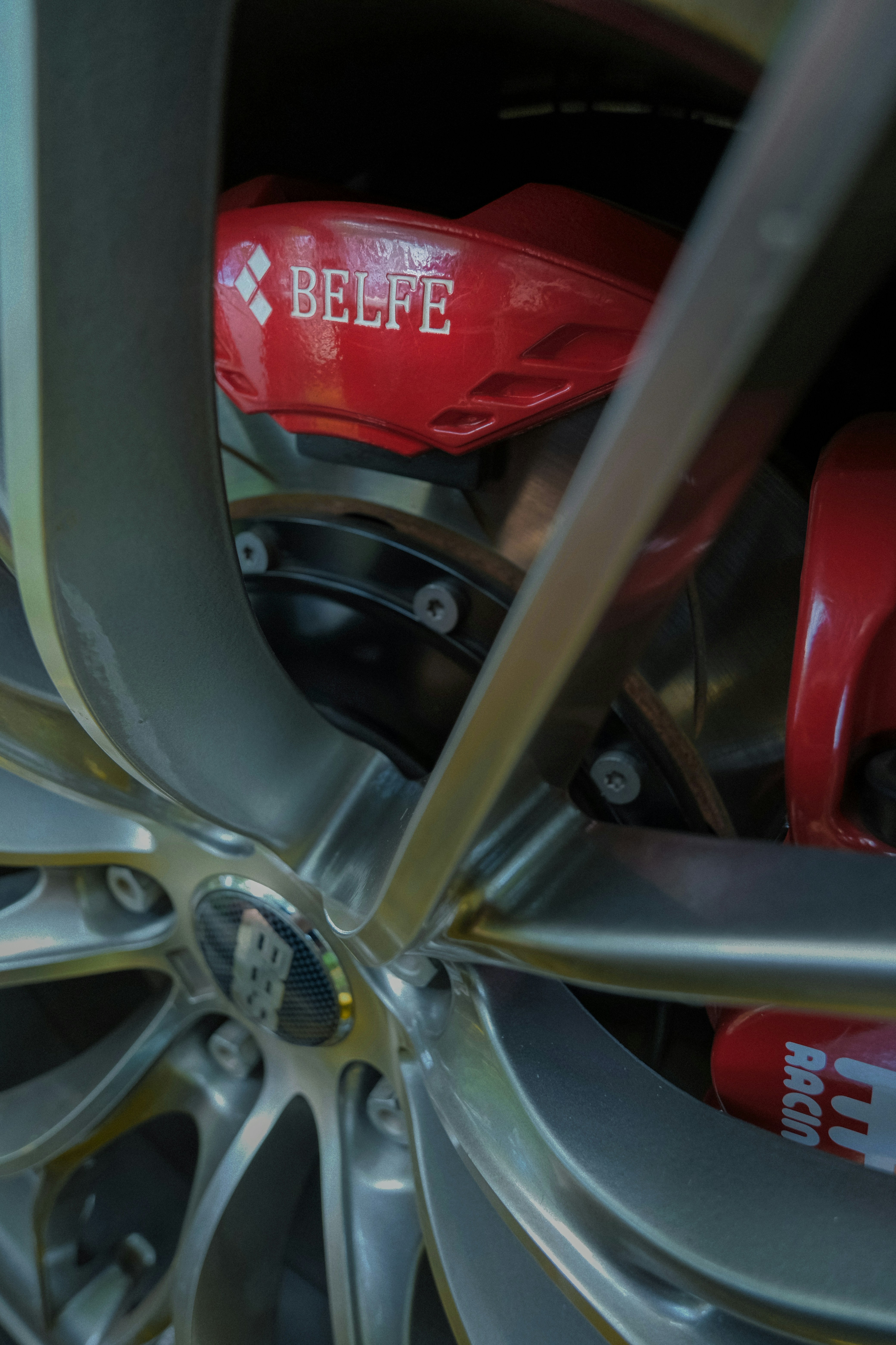 Red Brembo Caliper Iridescent Spokes: A Car’s Engineered Pulse