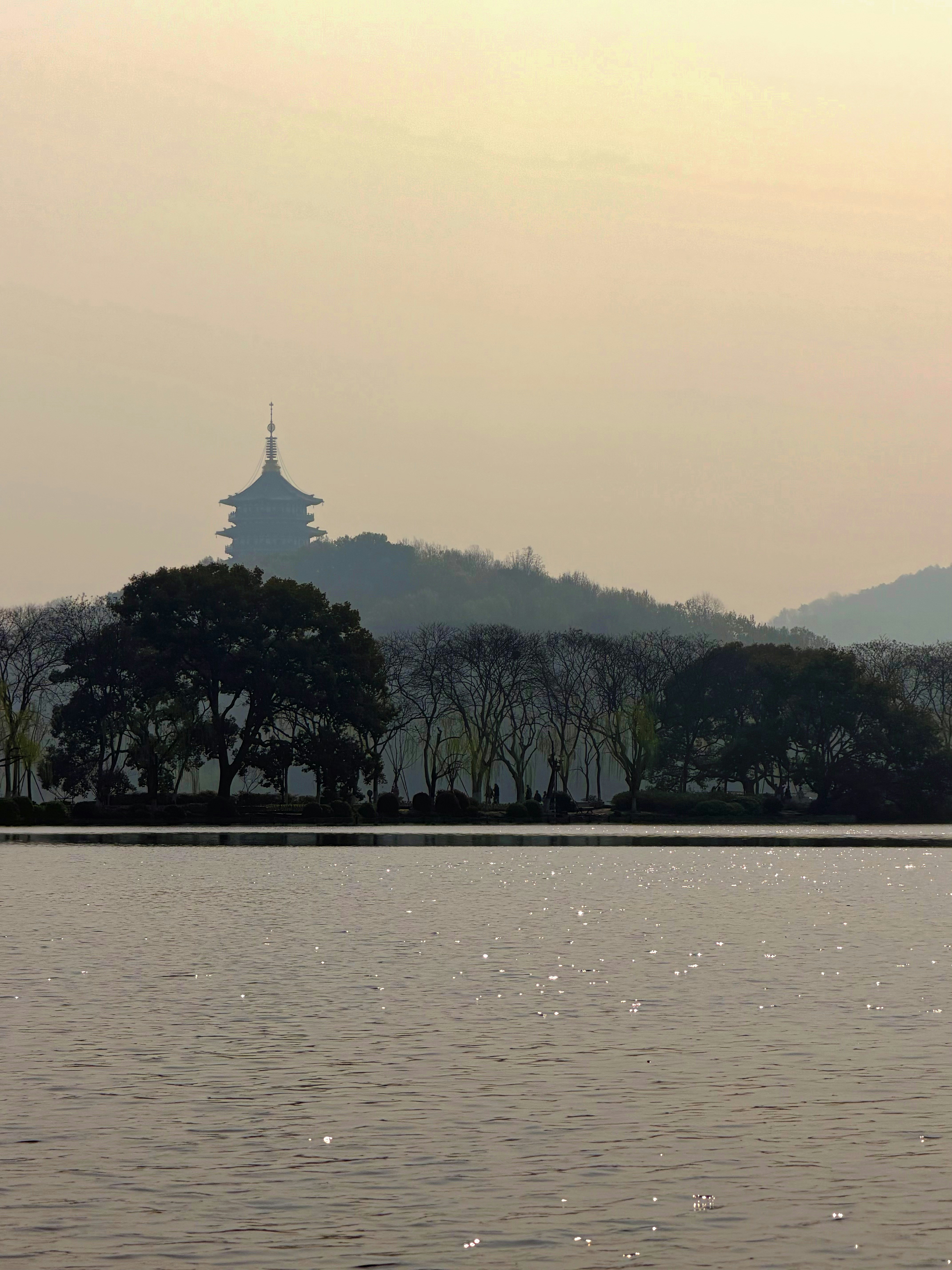 Silhouette of a Pagoda over a tranquil lake at dusk