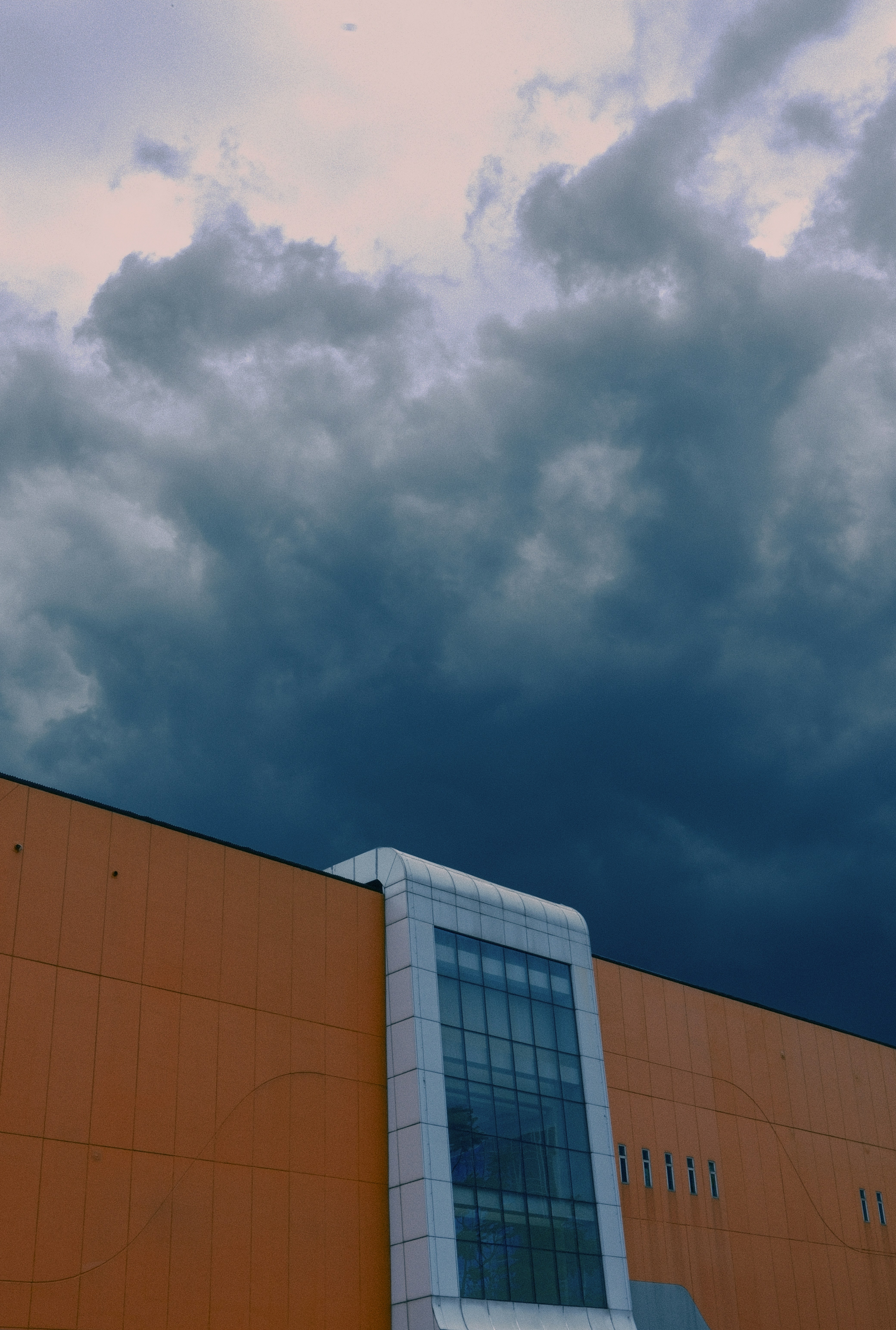 Angular Facade Under A Dusk-Heavy Sky