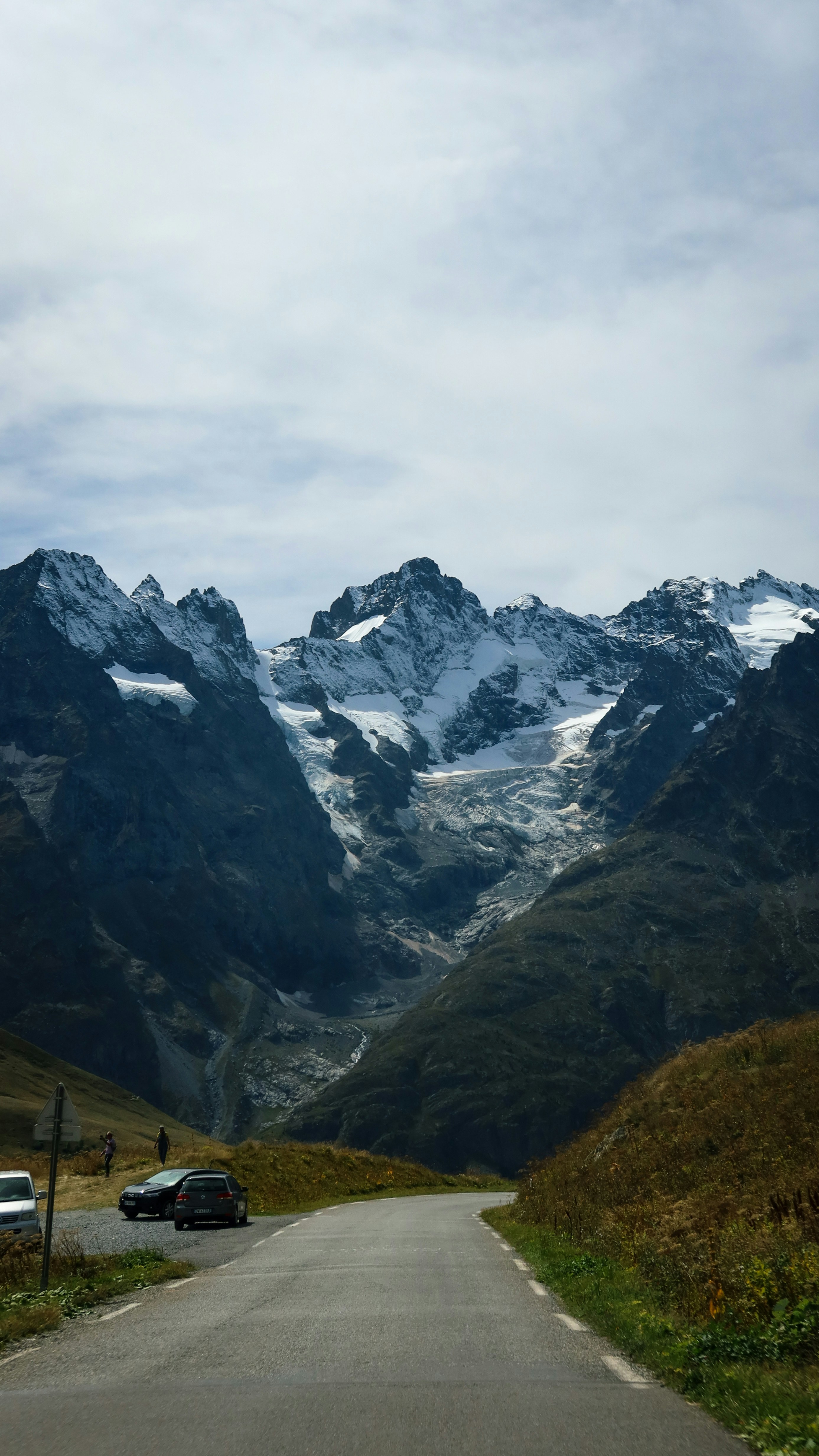 Road to the Glacial Highlands: A Mountain Pass Under Snow-Capped Peaks