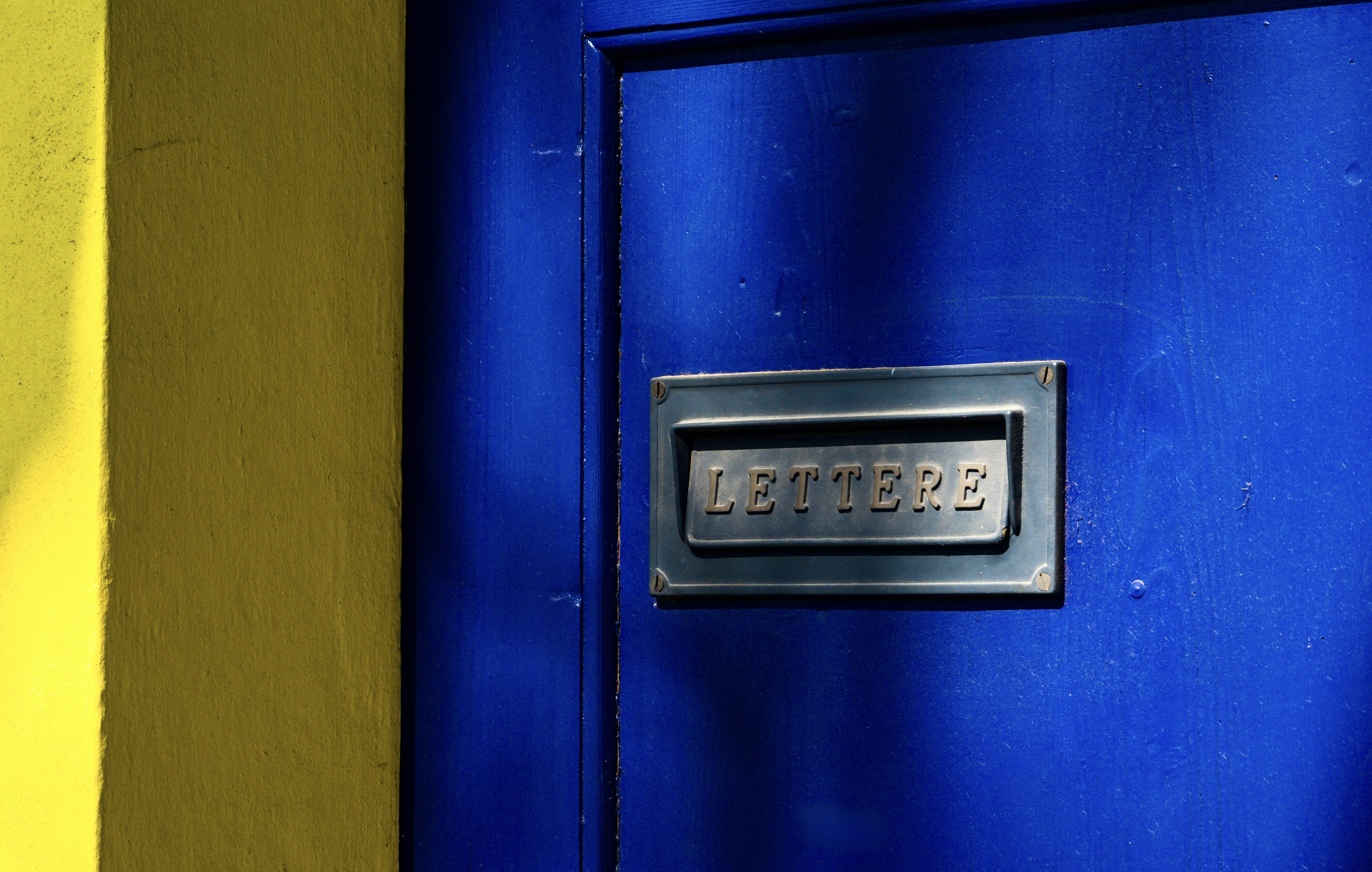 Blue Door Pulse: A Yellow Strip Framing a Mailbox