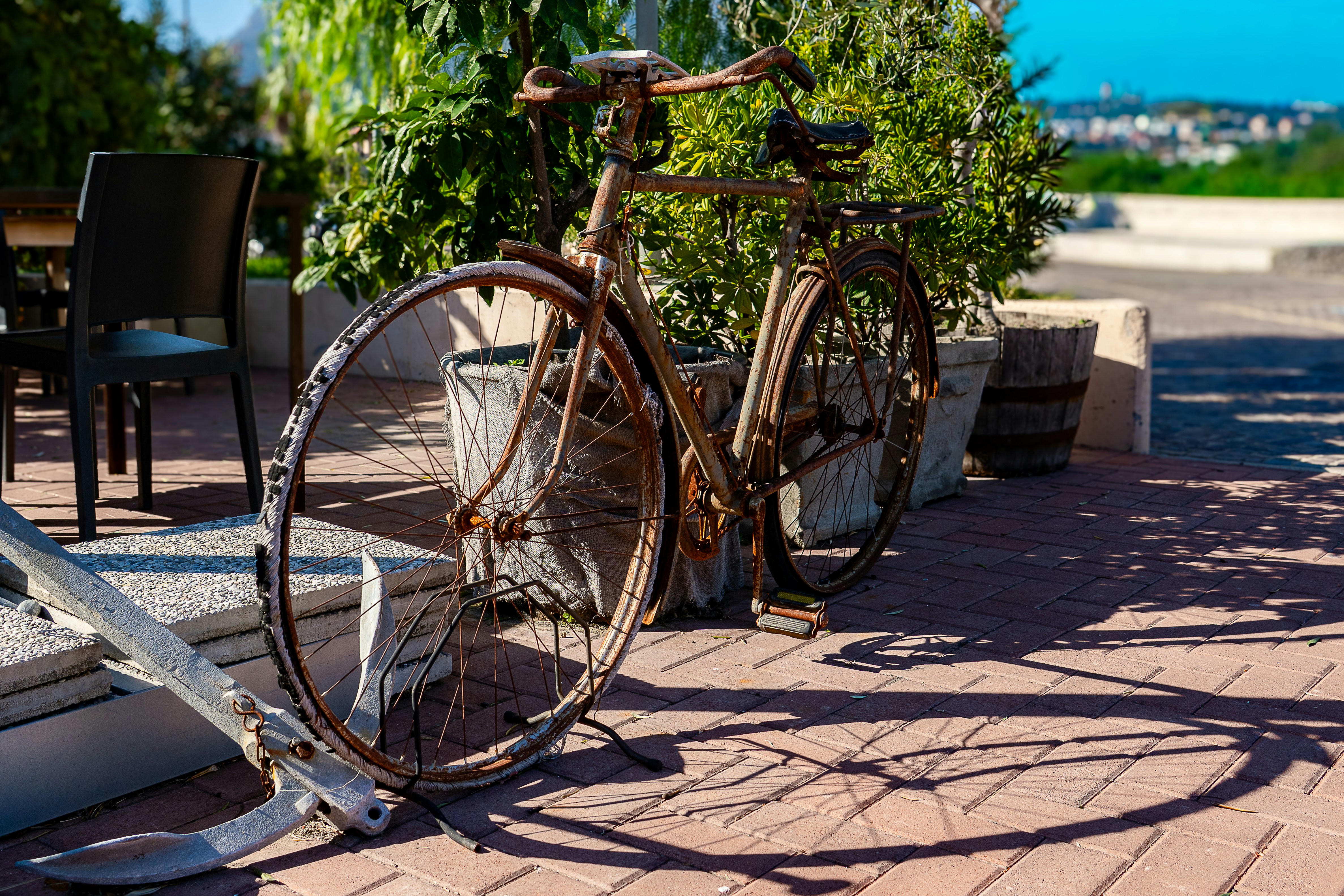 Rust and Shadow: A Bicycle Resting in the Sunlit Courtyard