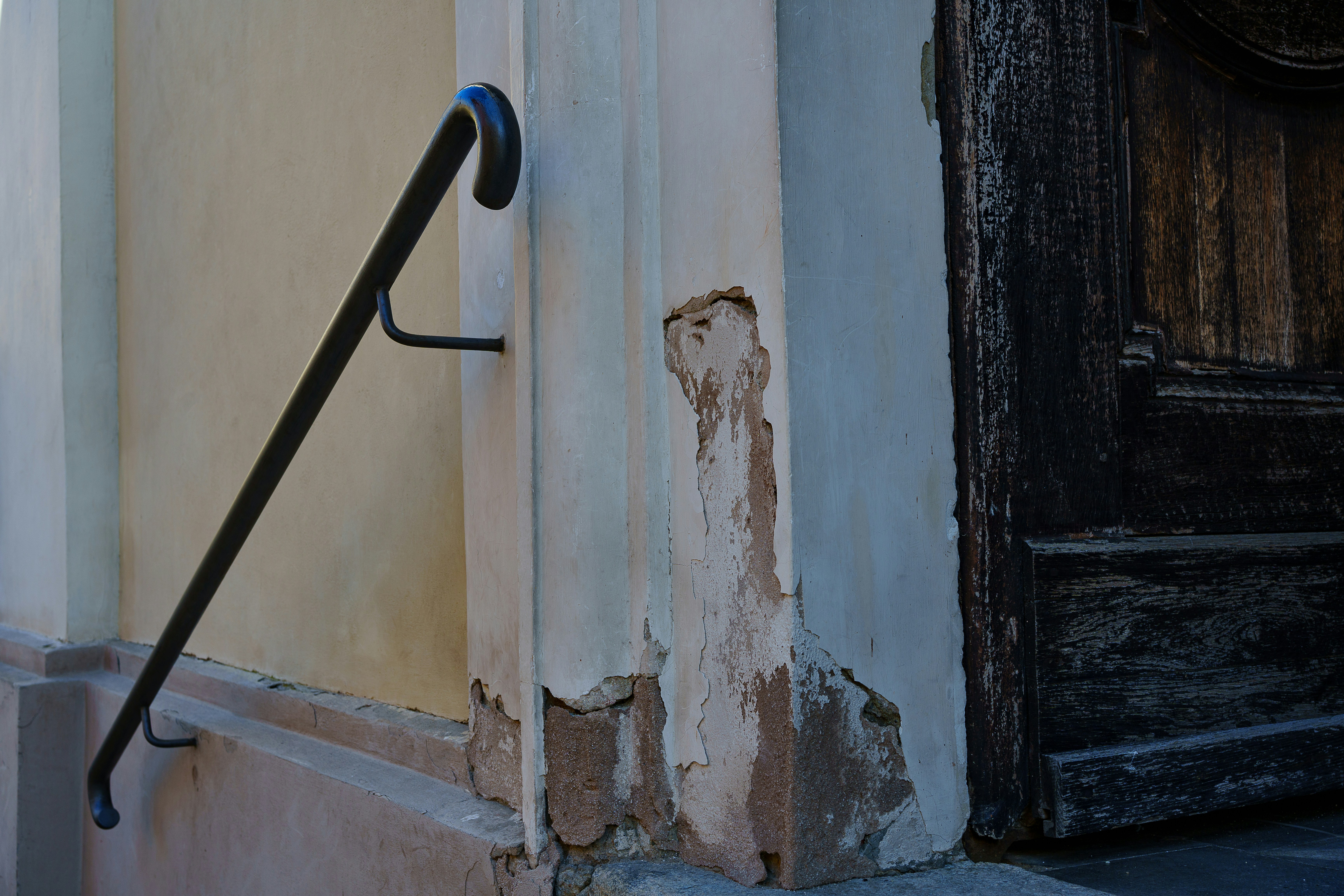 Worn Stairs and Handrail at a Weathered Corner