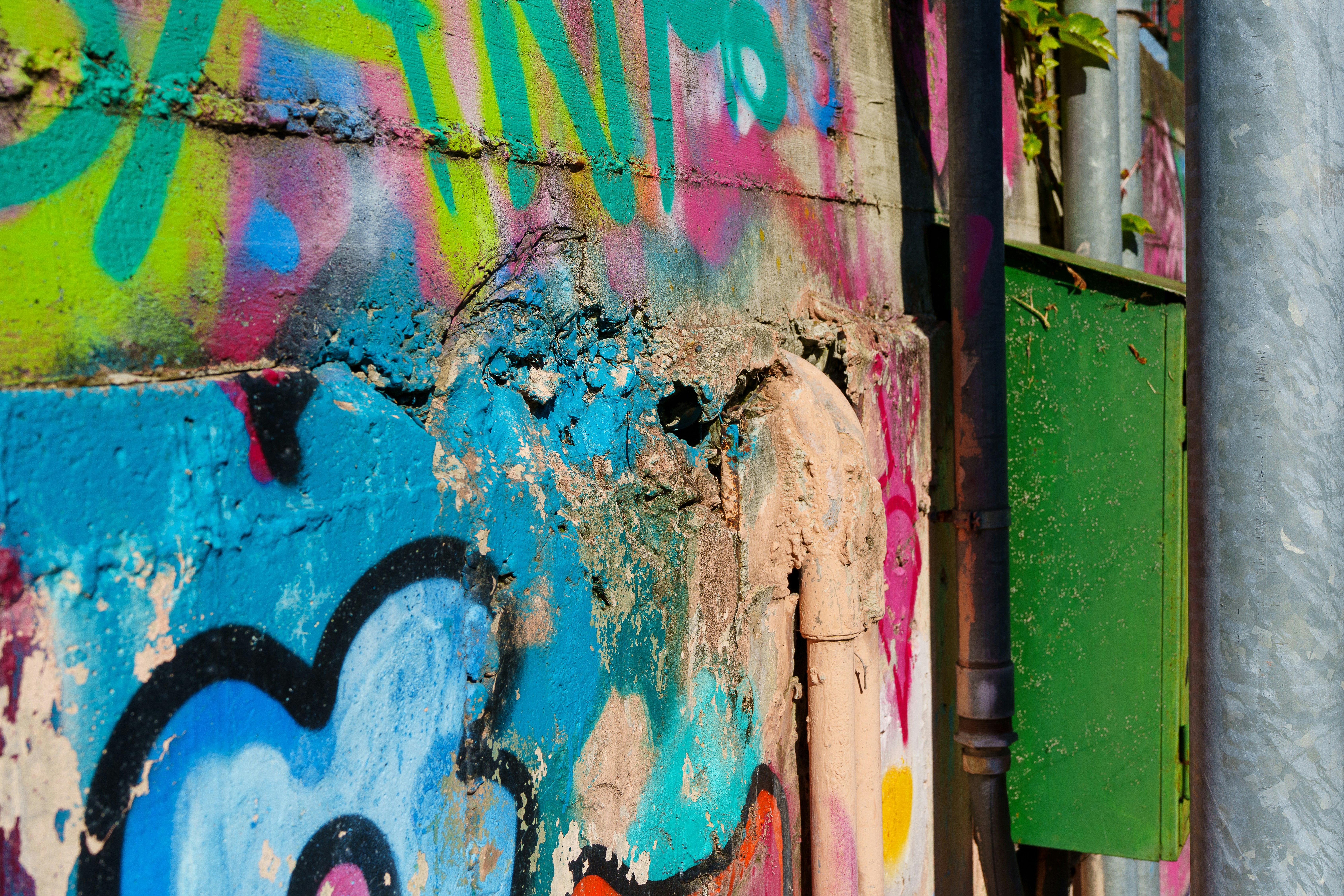Cracked Concrete Canvas: Neon Graffiti etched with a Weathered Pipe