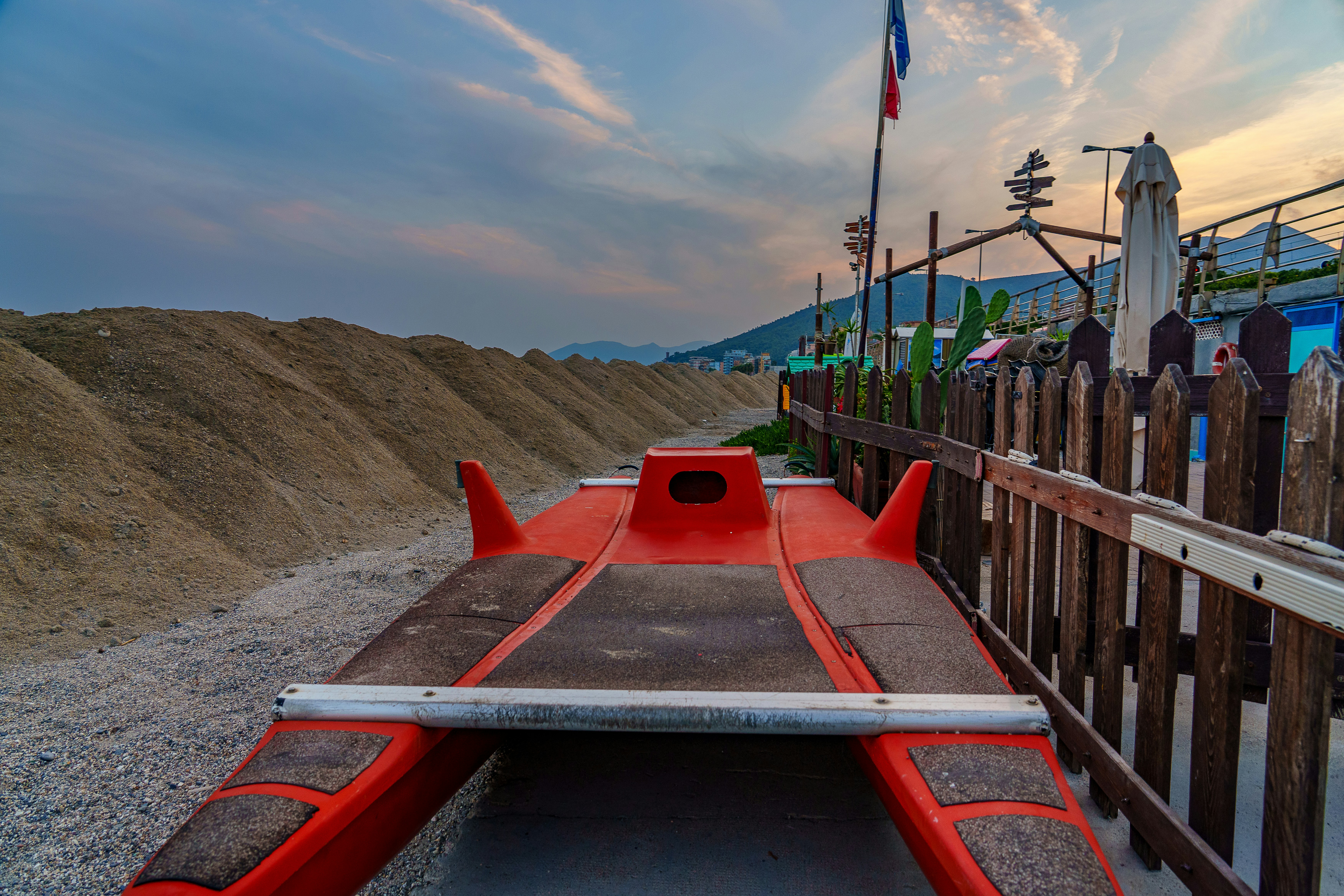 Red Sled at Sunset Pier: A Deserted Beachfront Launch Pad