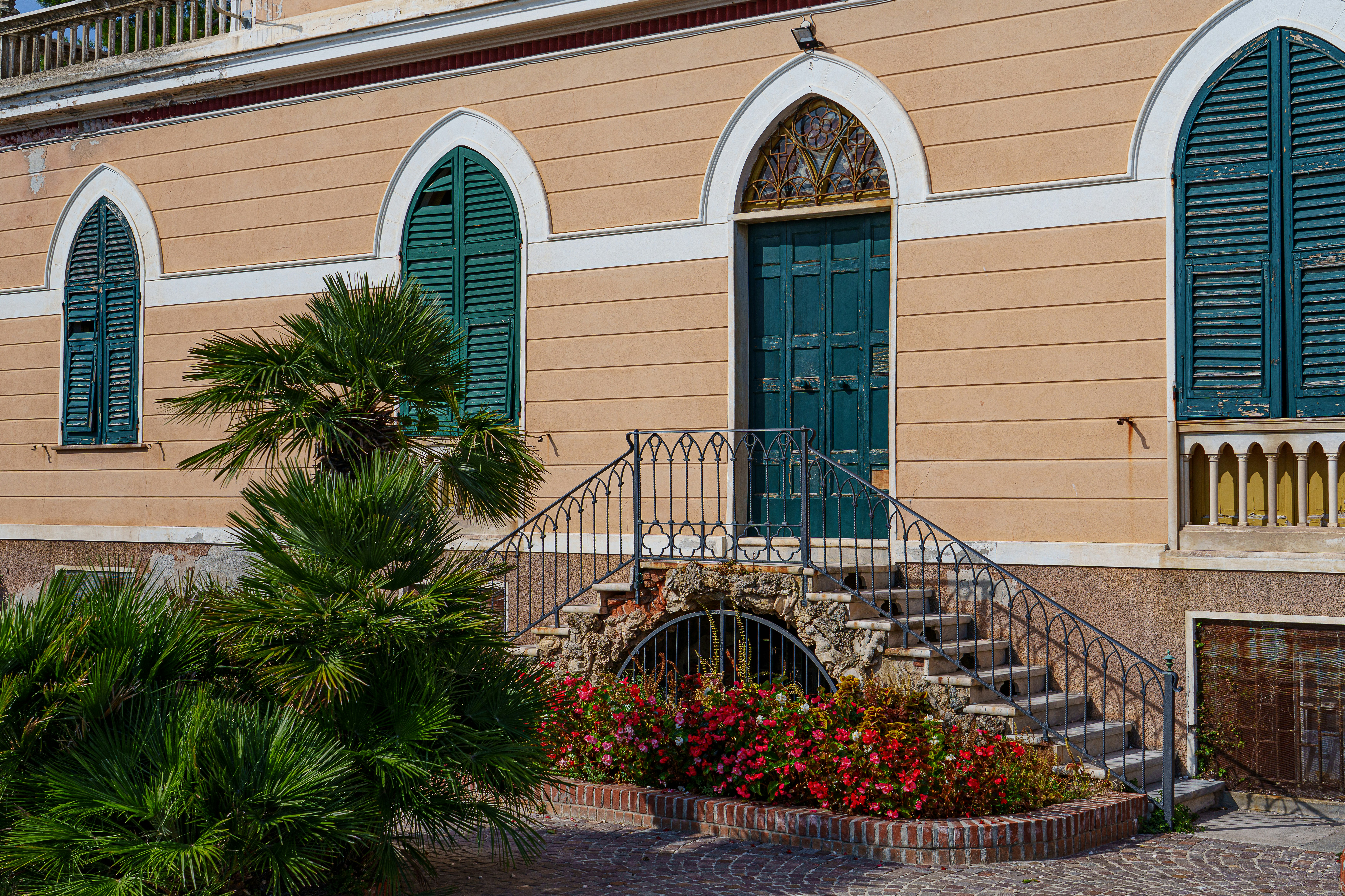 Terracotta Facade and Velvet-green Arches