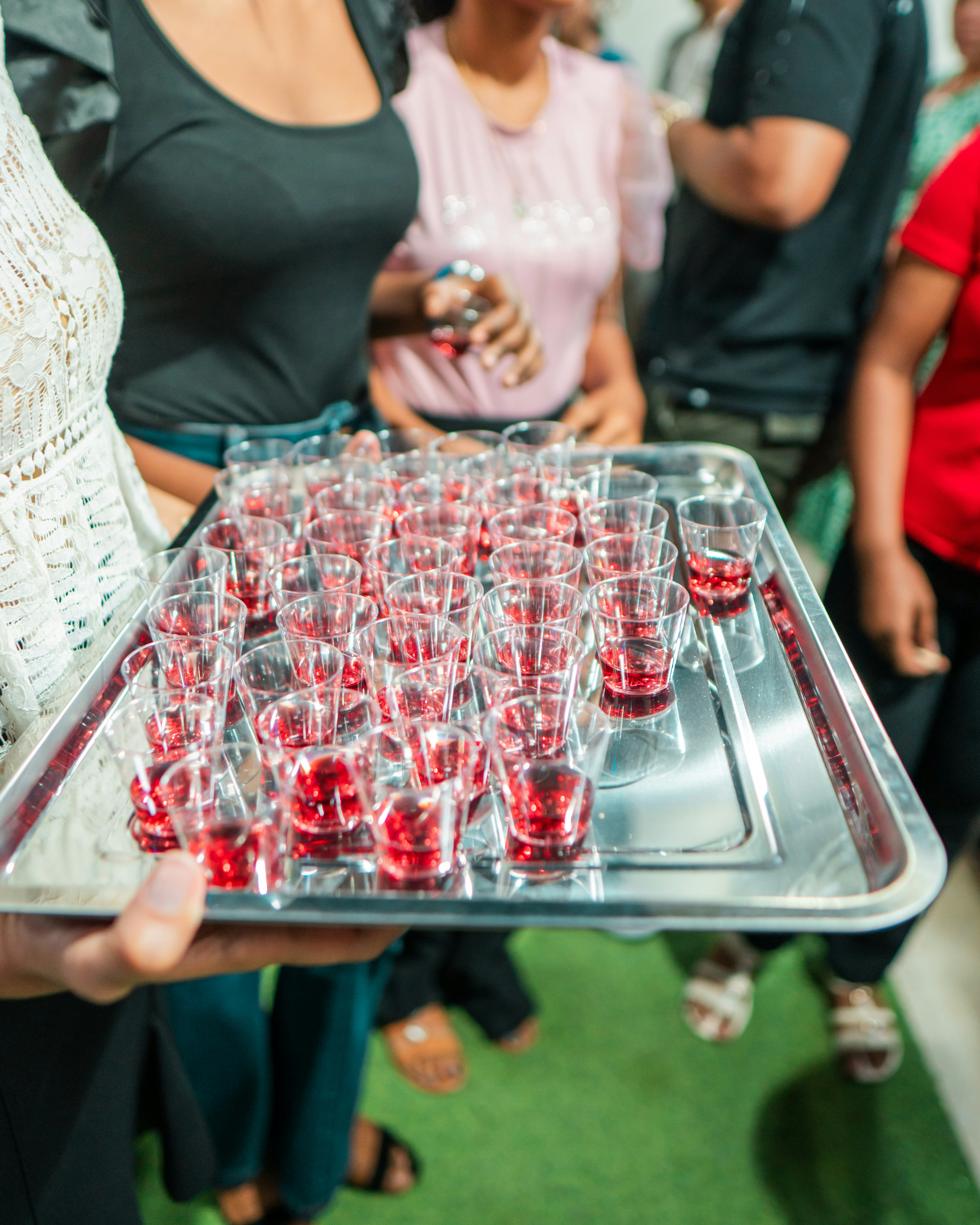 Tray of Red-Glassed Cheer: A Crowd-Filled Celebration at Eye Level