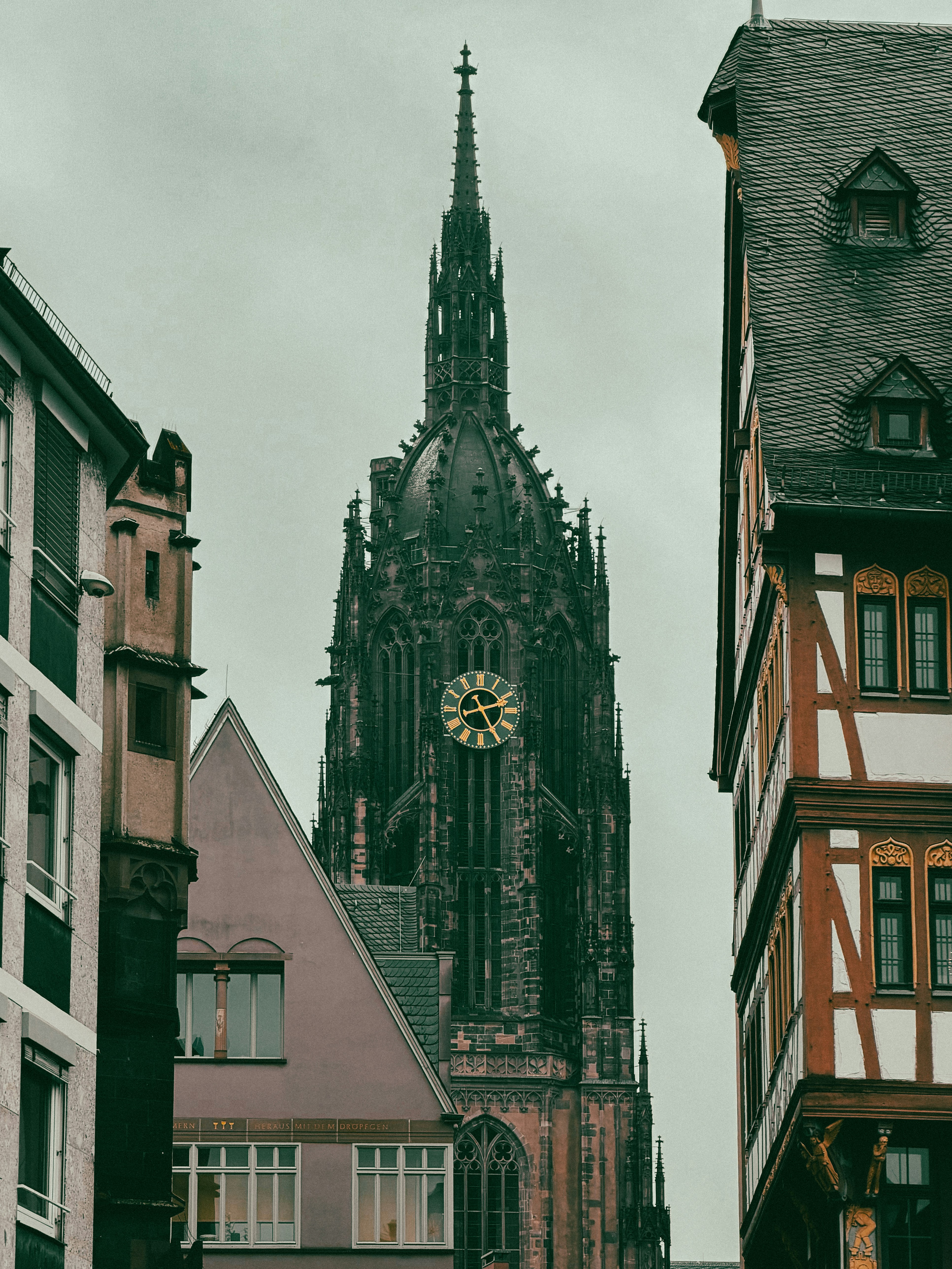 Gothic Spire Between Timbered Facades