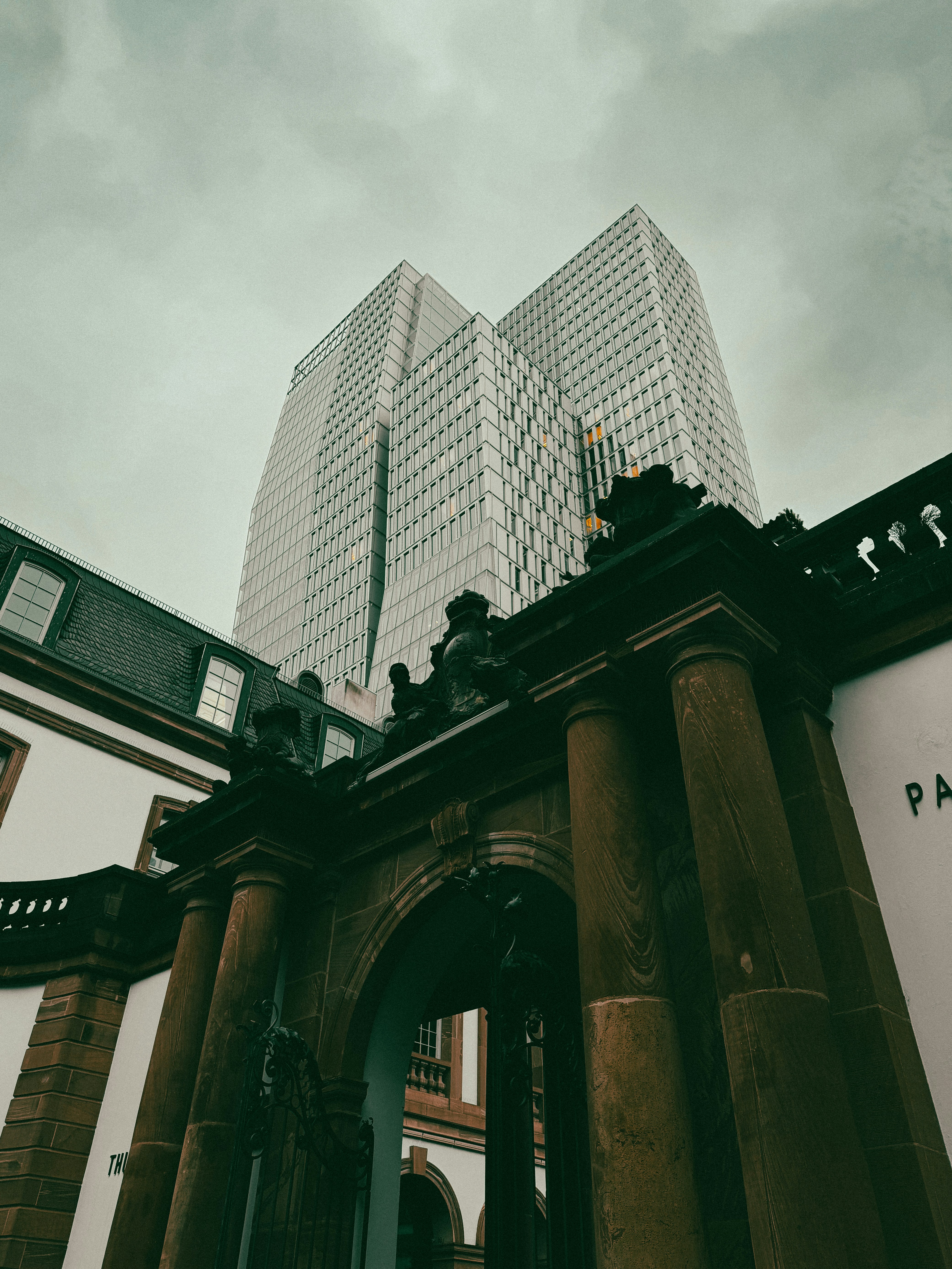 Colossal Facades: A City Gate Framed by Skyward Glass