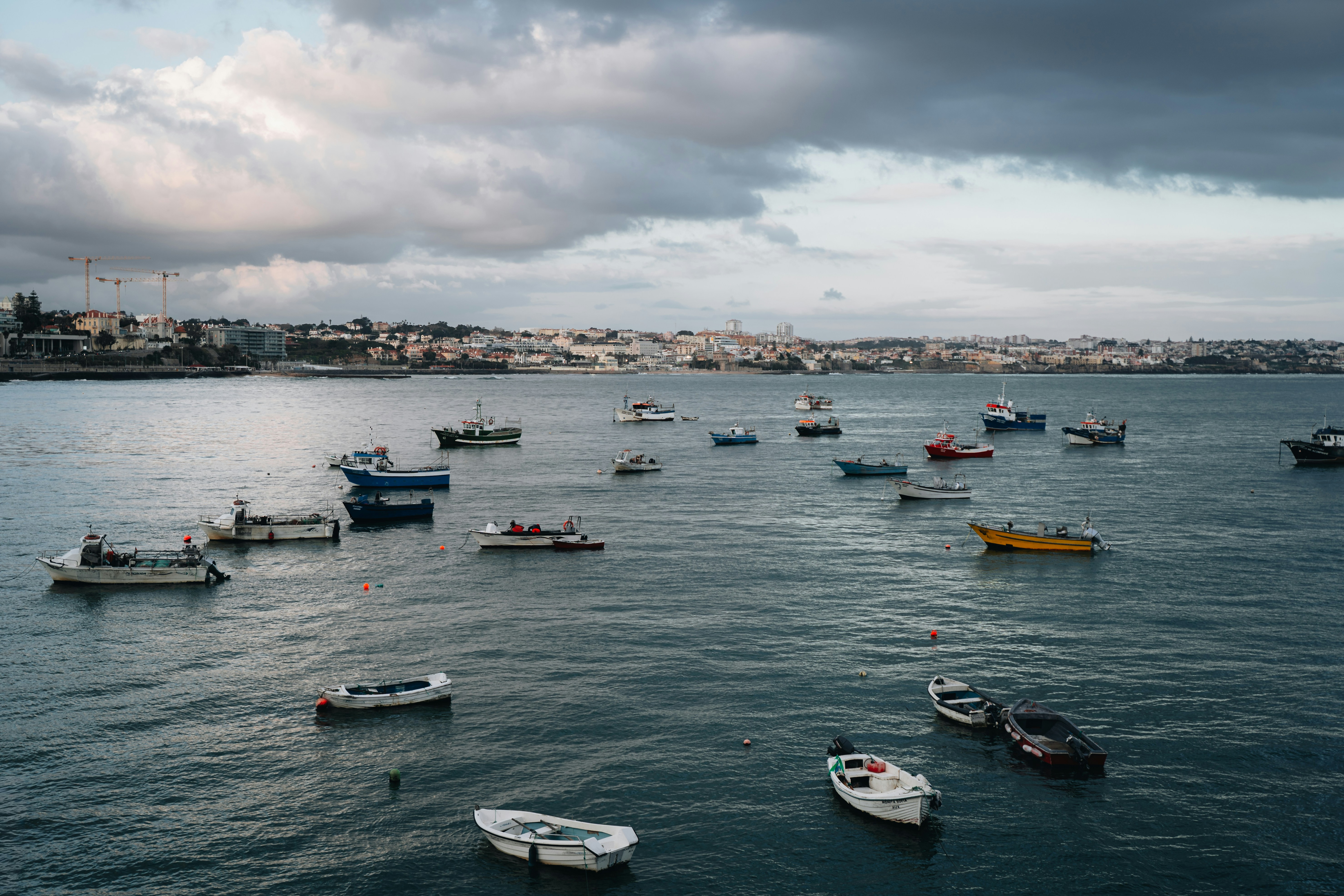 Harbor Mosaic: Boats Rest at Dusk Under Quiet Skies