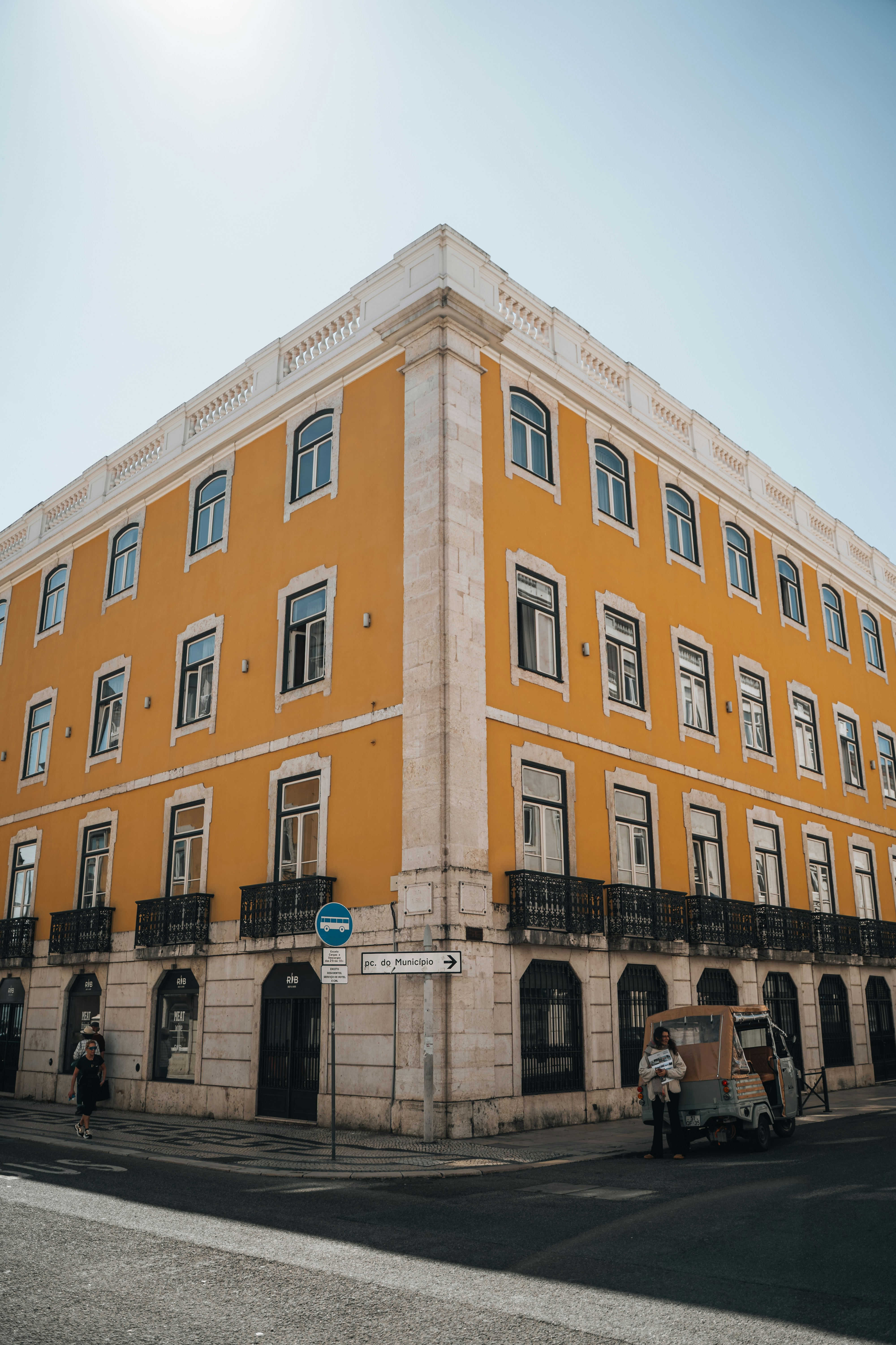Sunlit Orange Facade: A Corner of Lisboa in Quiet Morning