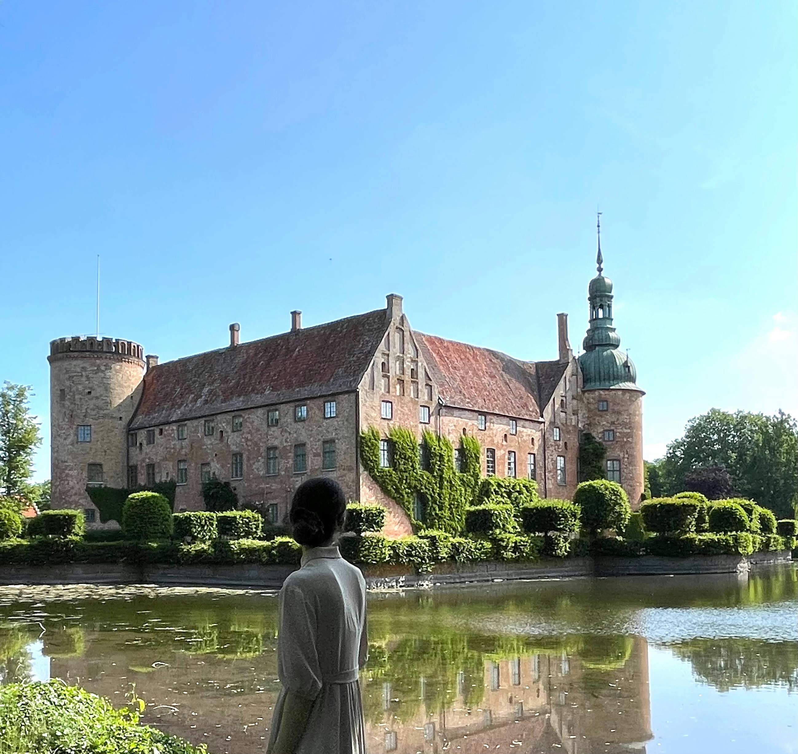 Reflections at a Riverside Keep: A Gentle Portrait by the Water