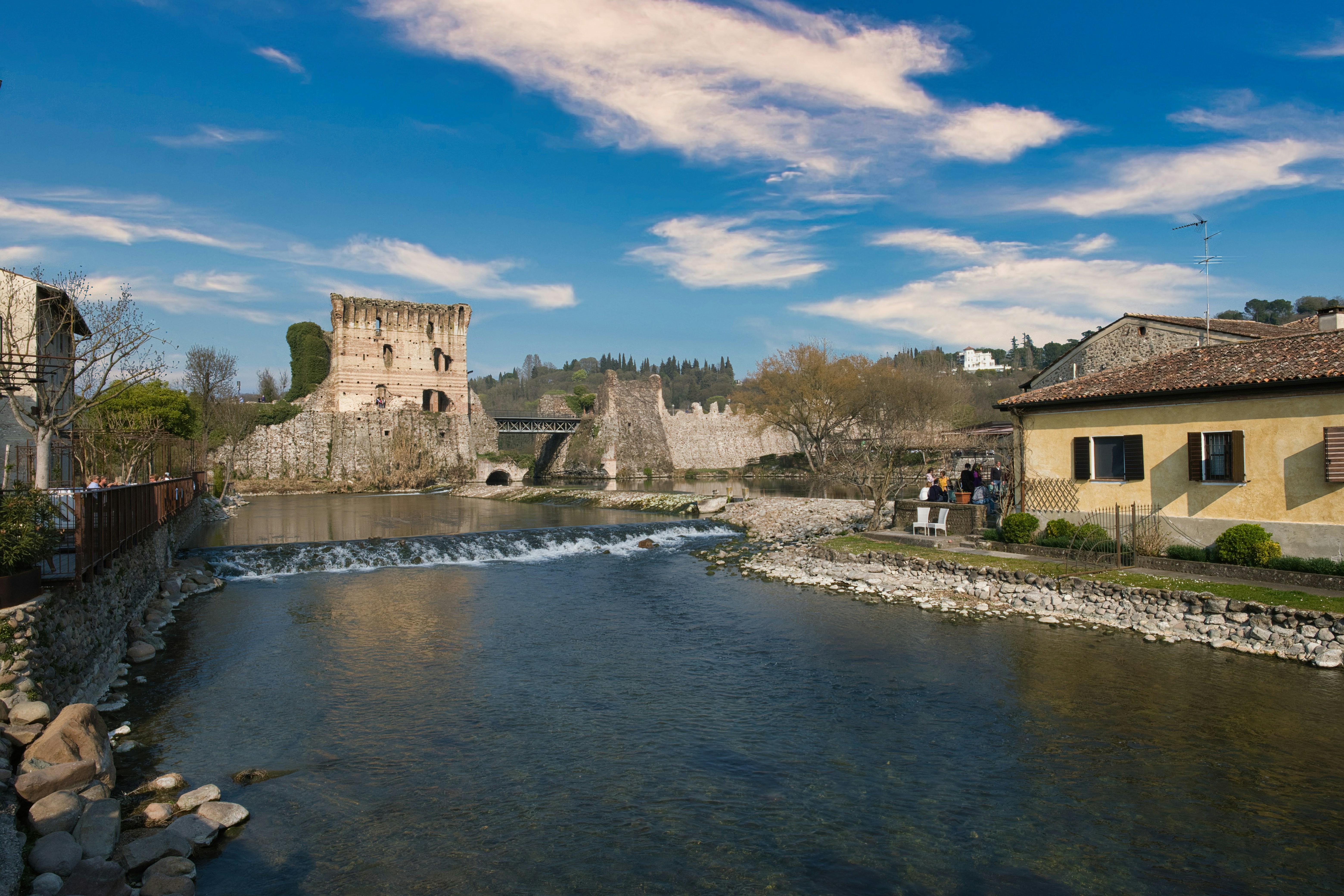 Riverside Ruins: A Quiet Crossing Beneath a Sunny Sky