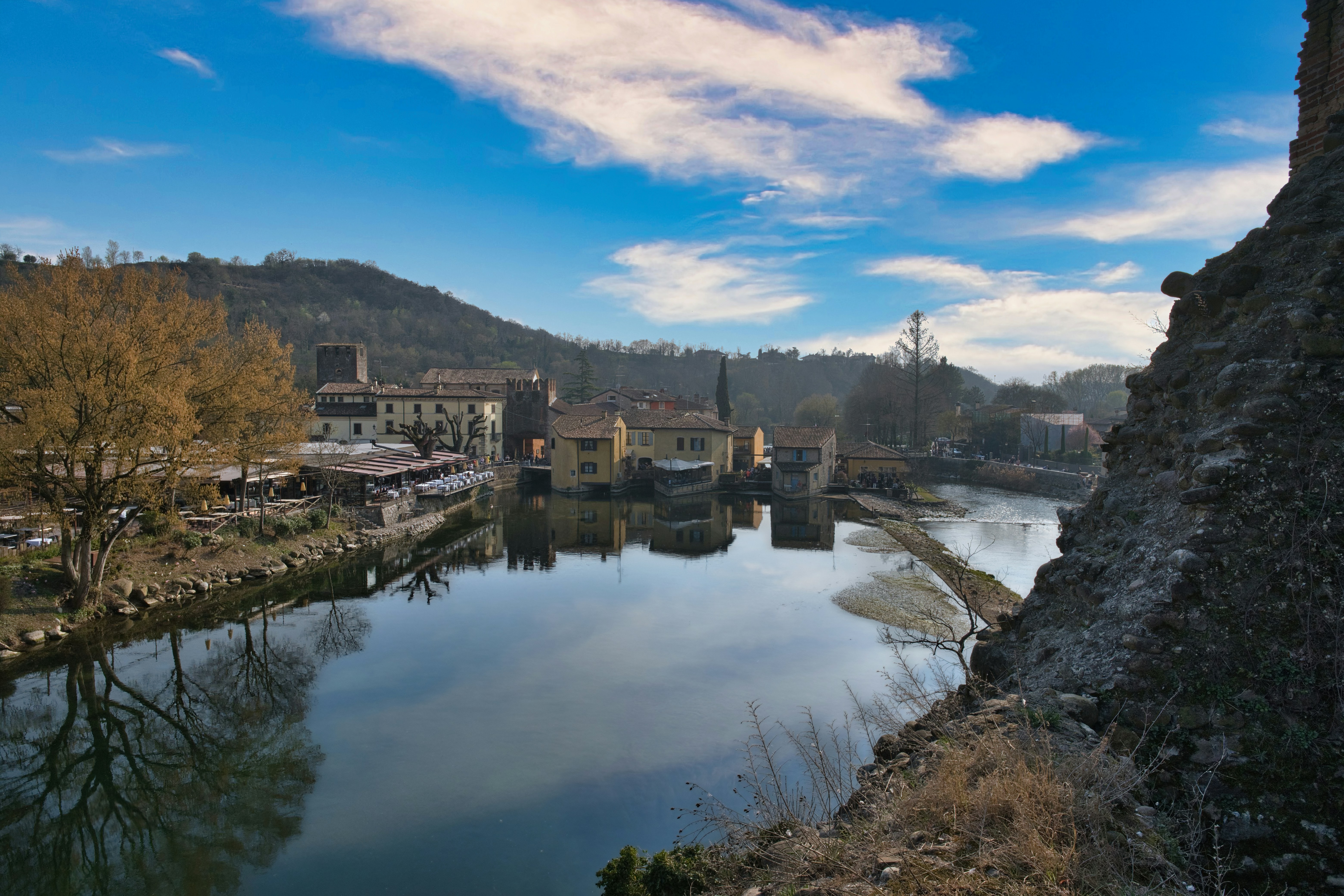Riverside Village Framed by an Ancient Wall