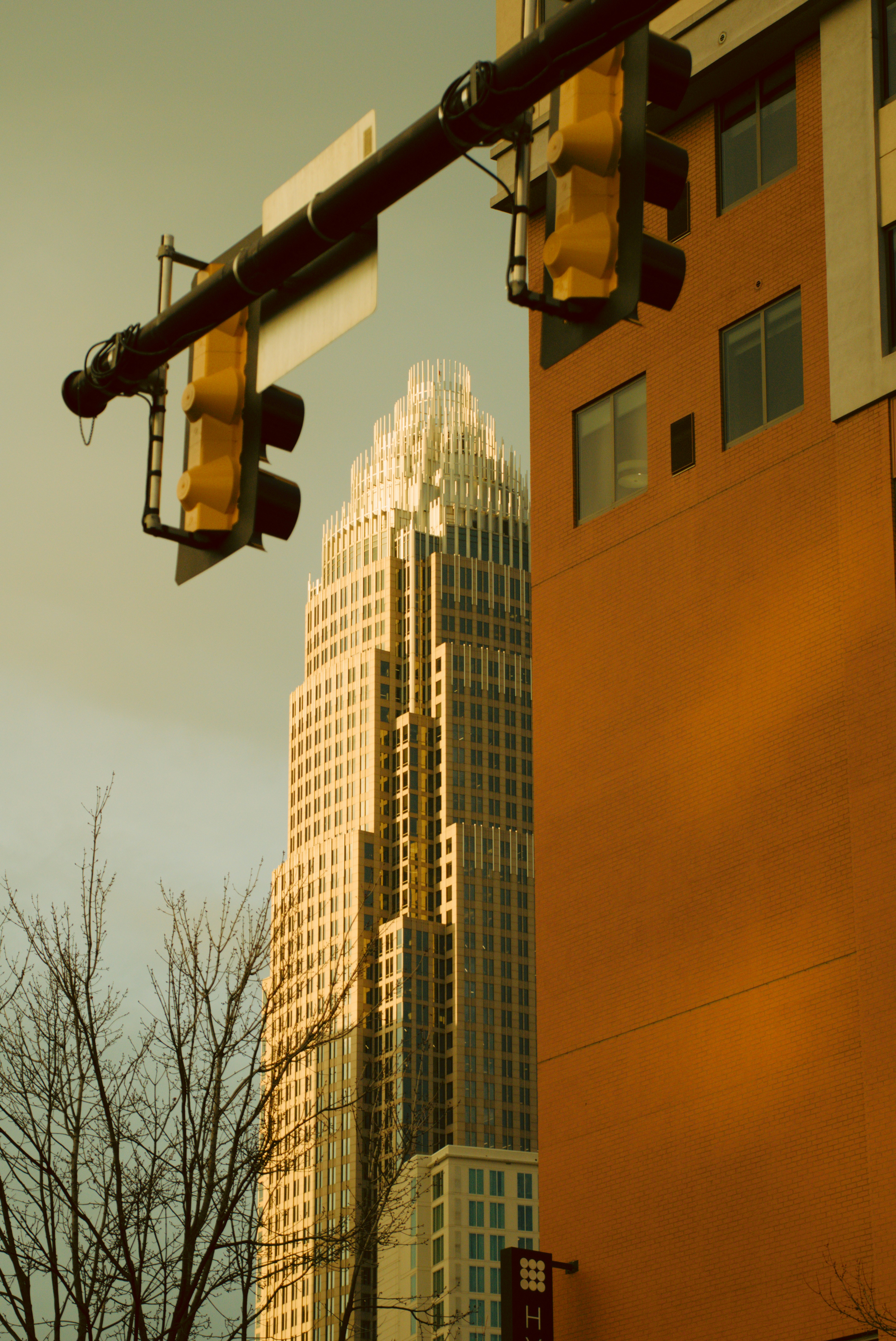 Urban Tower Framed by Traffic Light and Brick Facade