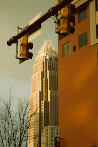 Urban Tower Framed by Traffic Light and Brick Facade