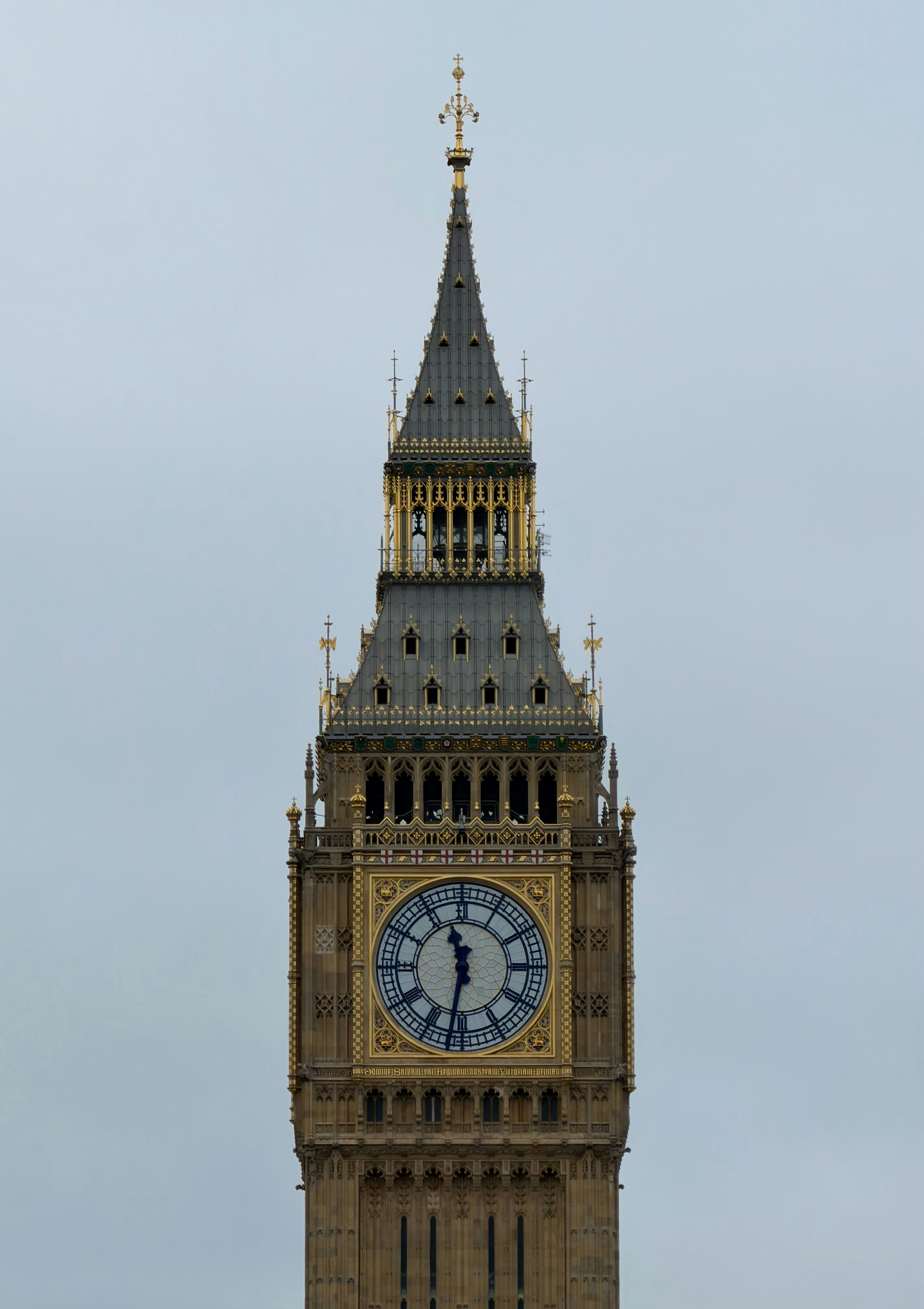 Clock Tower in Focus: The Golden Spire Reaching Skyward