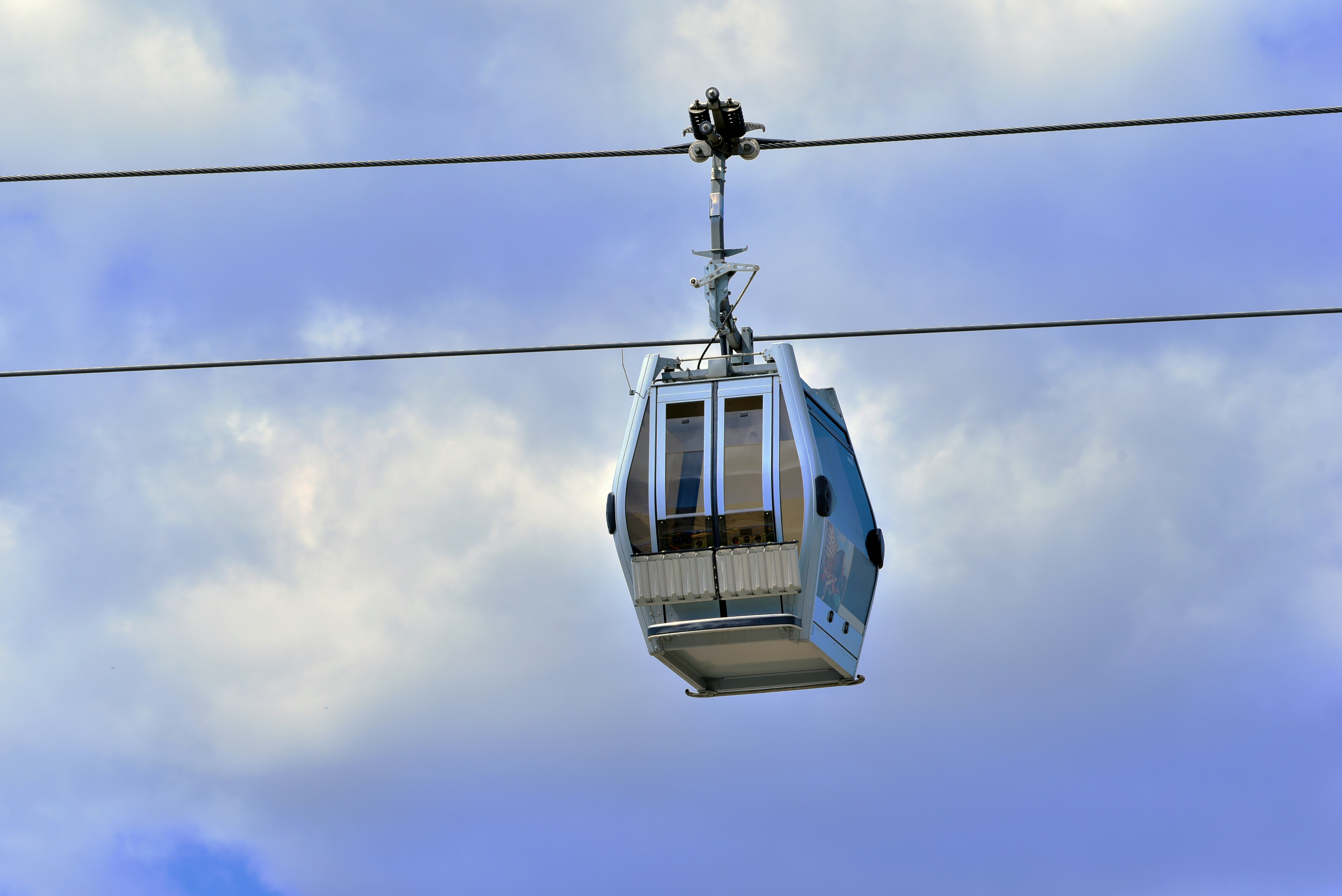 Midair Cable Car Looming Against a Clear Sky
