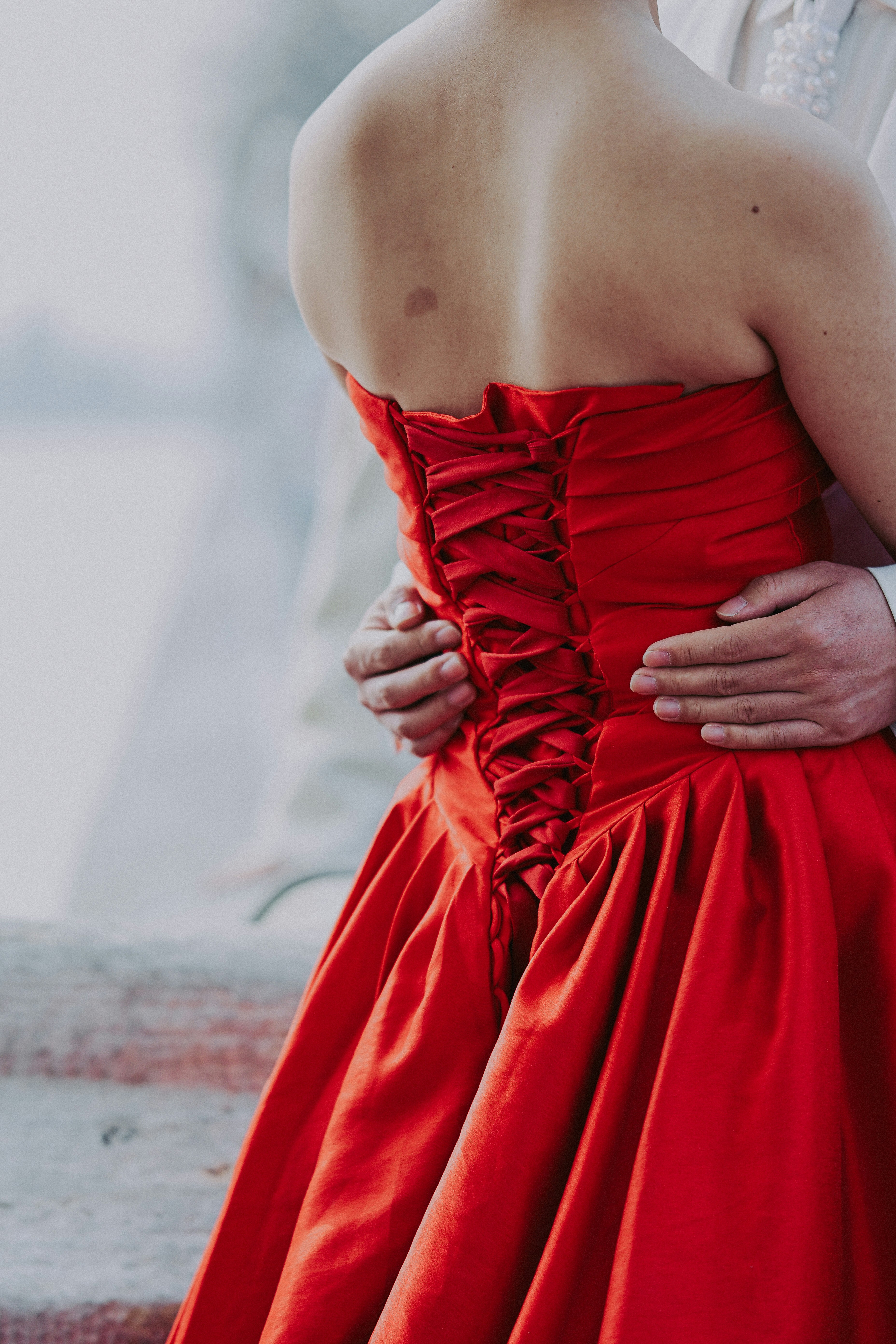 Crimson Gown Embrace: A Close-Tilt of Lace and Back