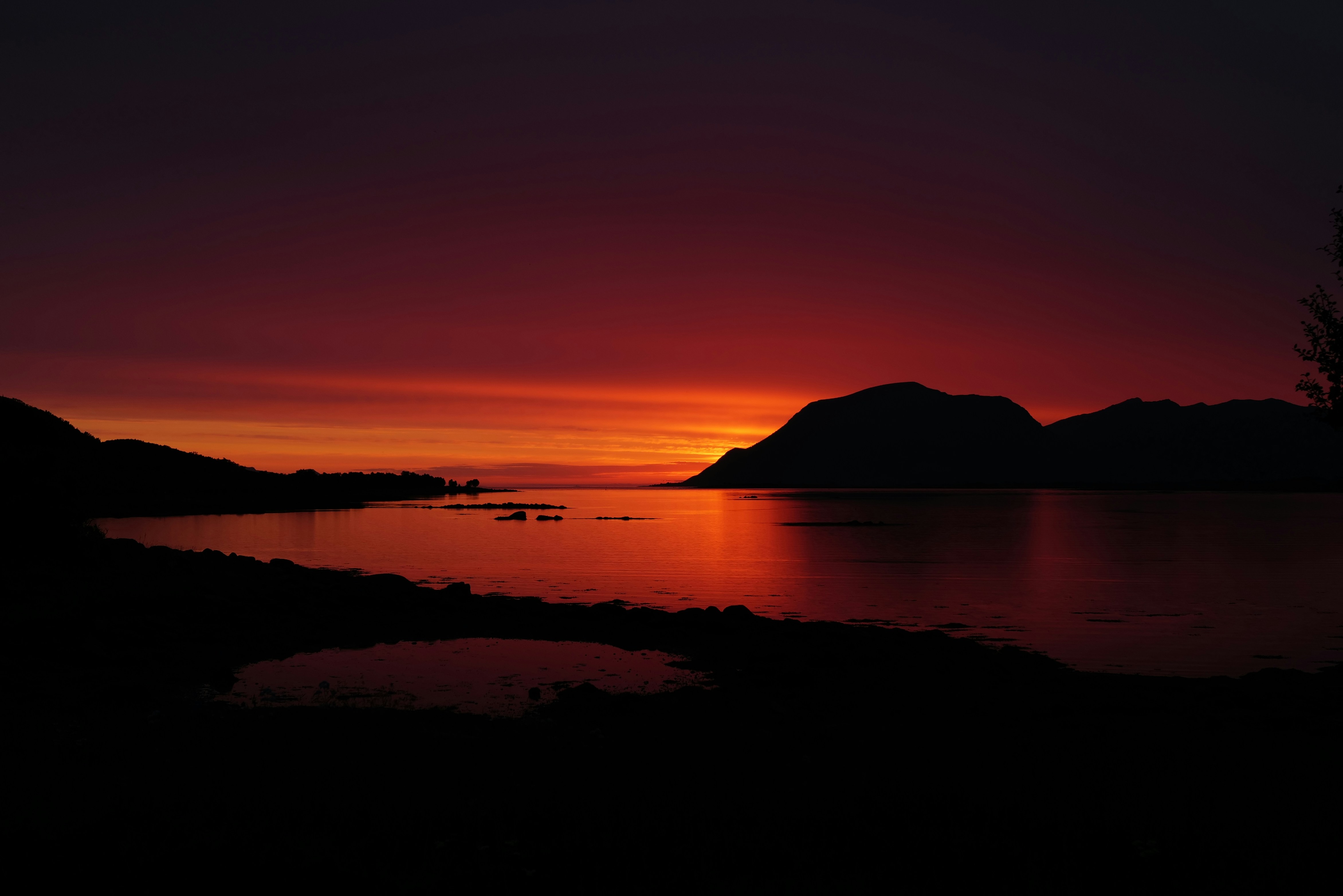 Crimson Horizon Over Quiet Fjord
