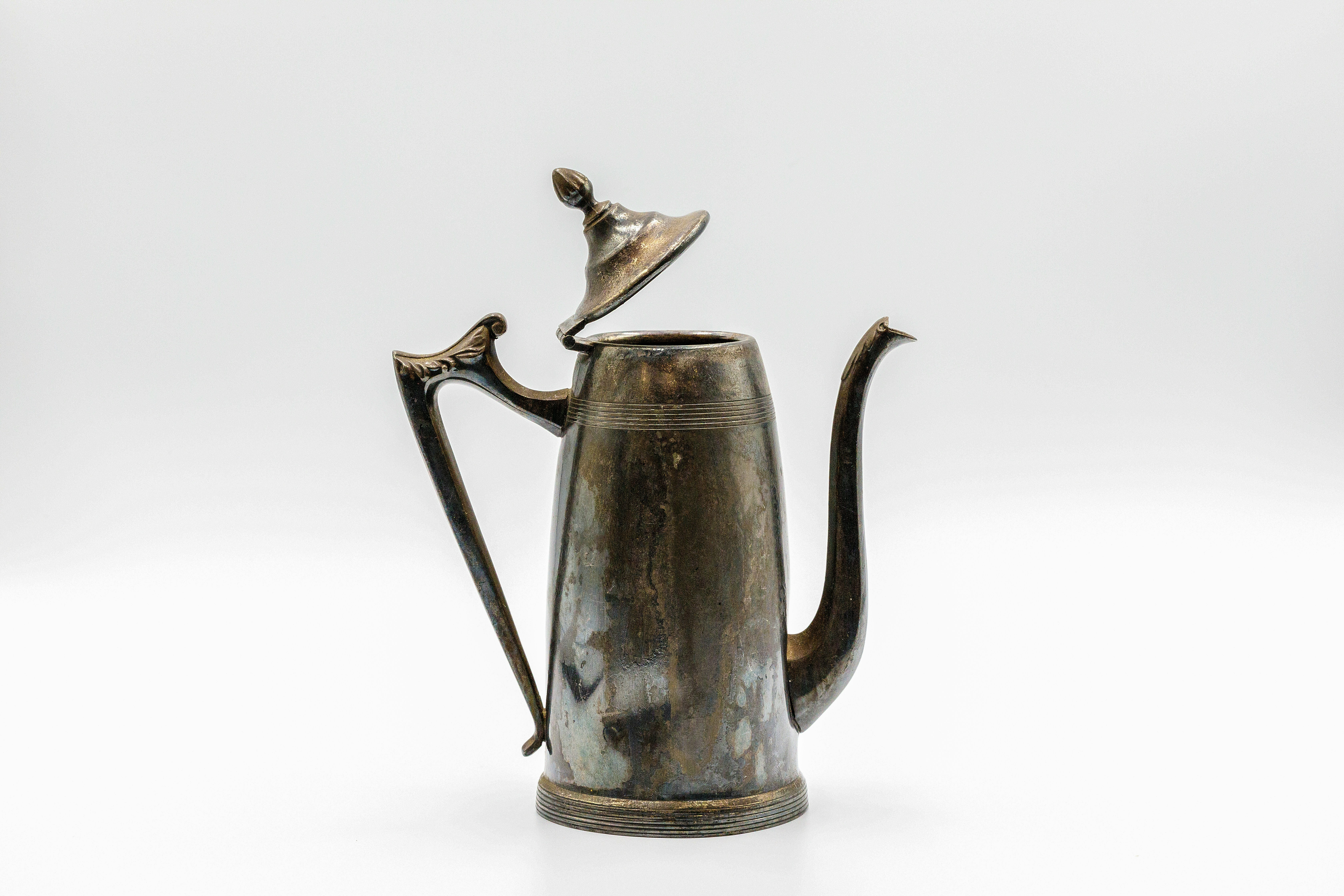 Weathered Teapot: Quiet Vessel with a Bold, Lean Spine